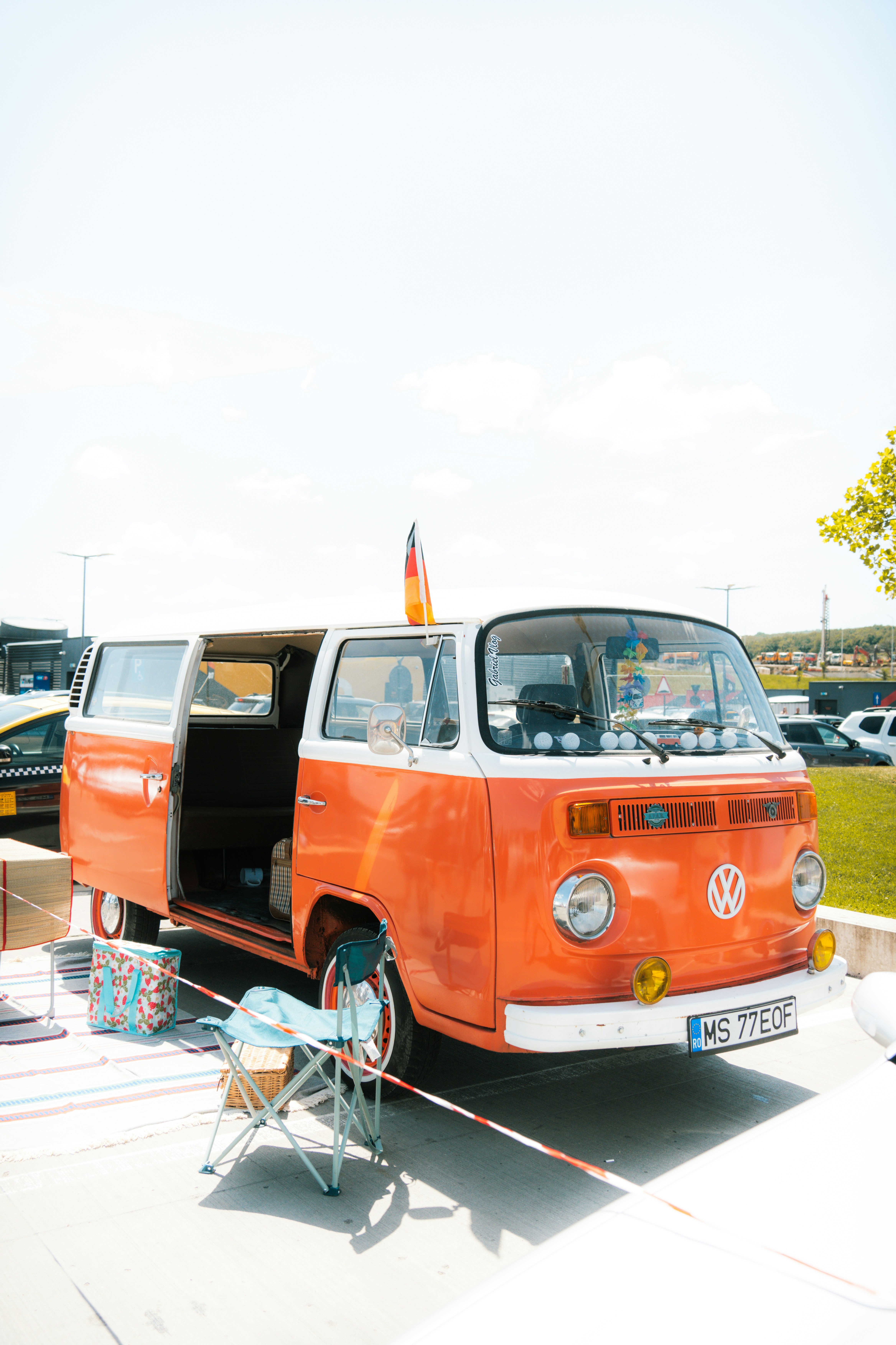 An orange vw bus parked in a parking lot photo – Free Automobile Image ...