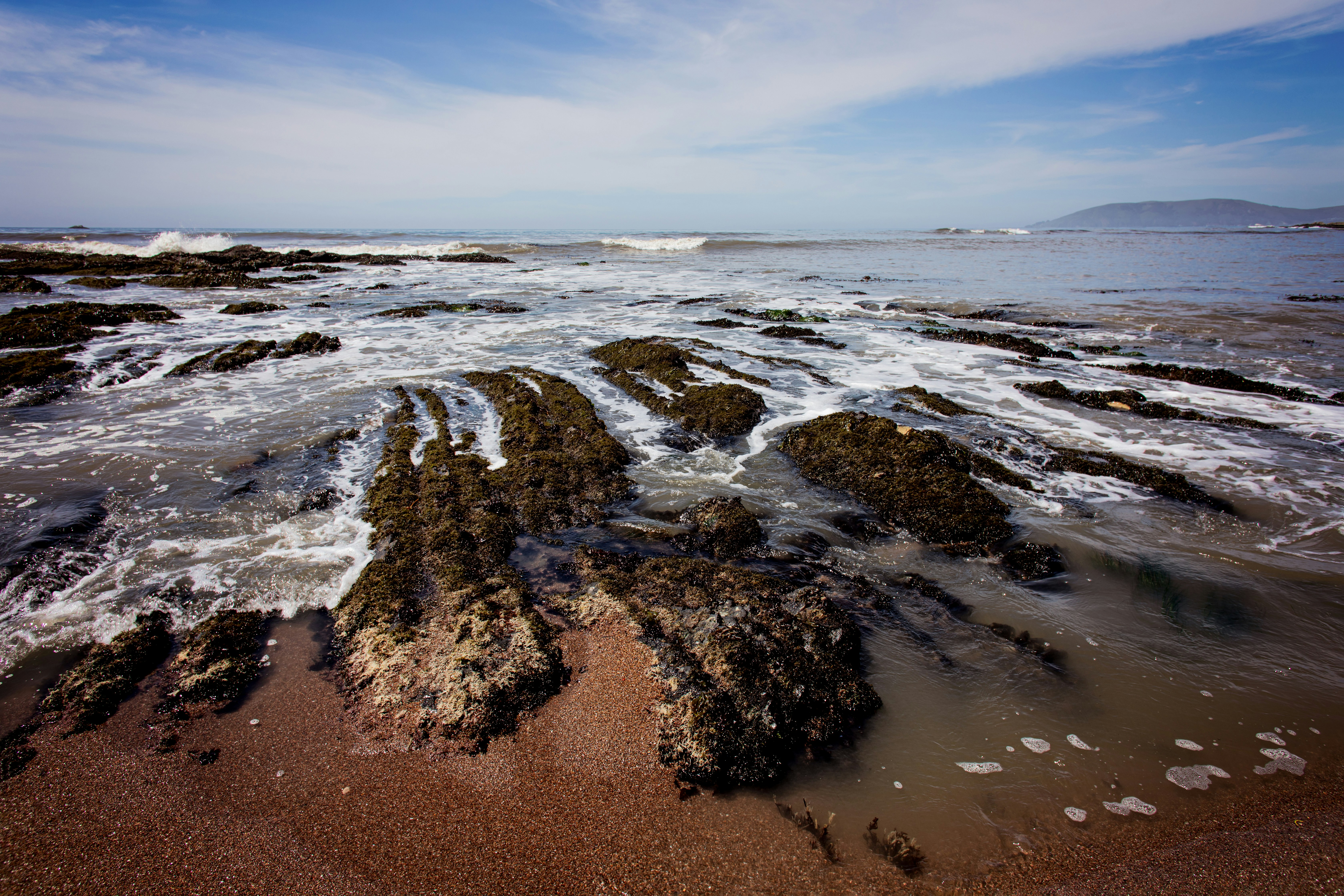 a sandy beach covered in lots of water