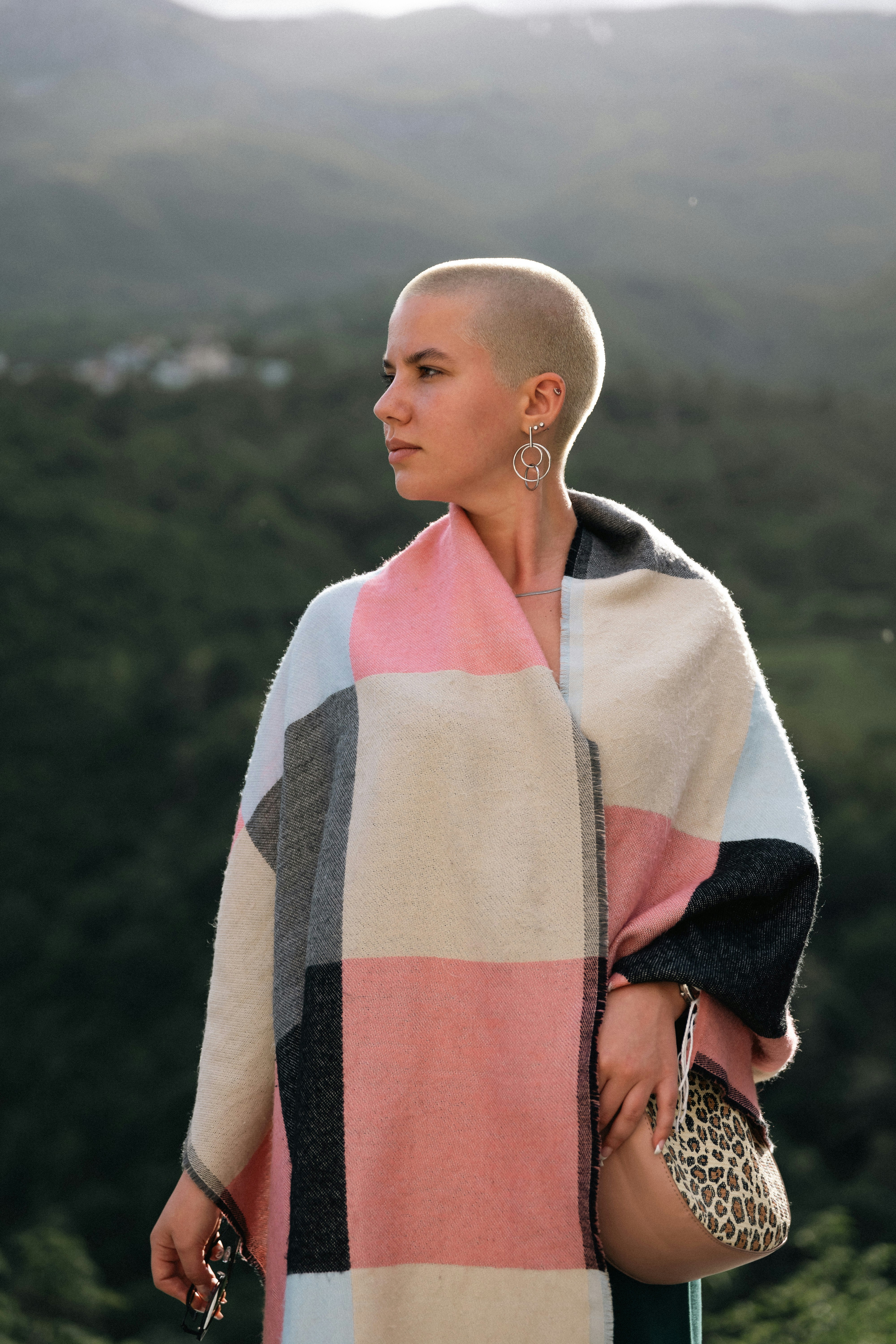 A woman with a shaved head is wrapped in a blanket photo – Free Woman ...