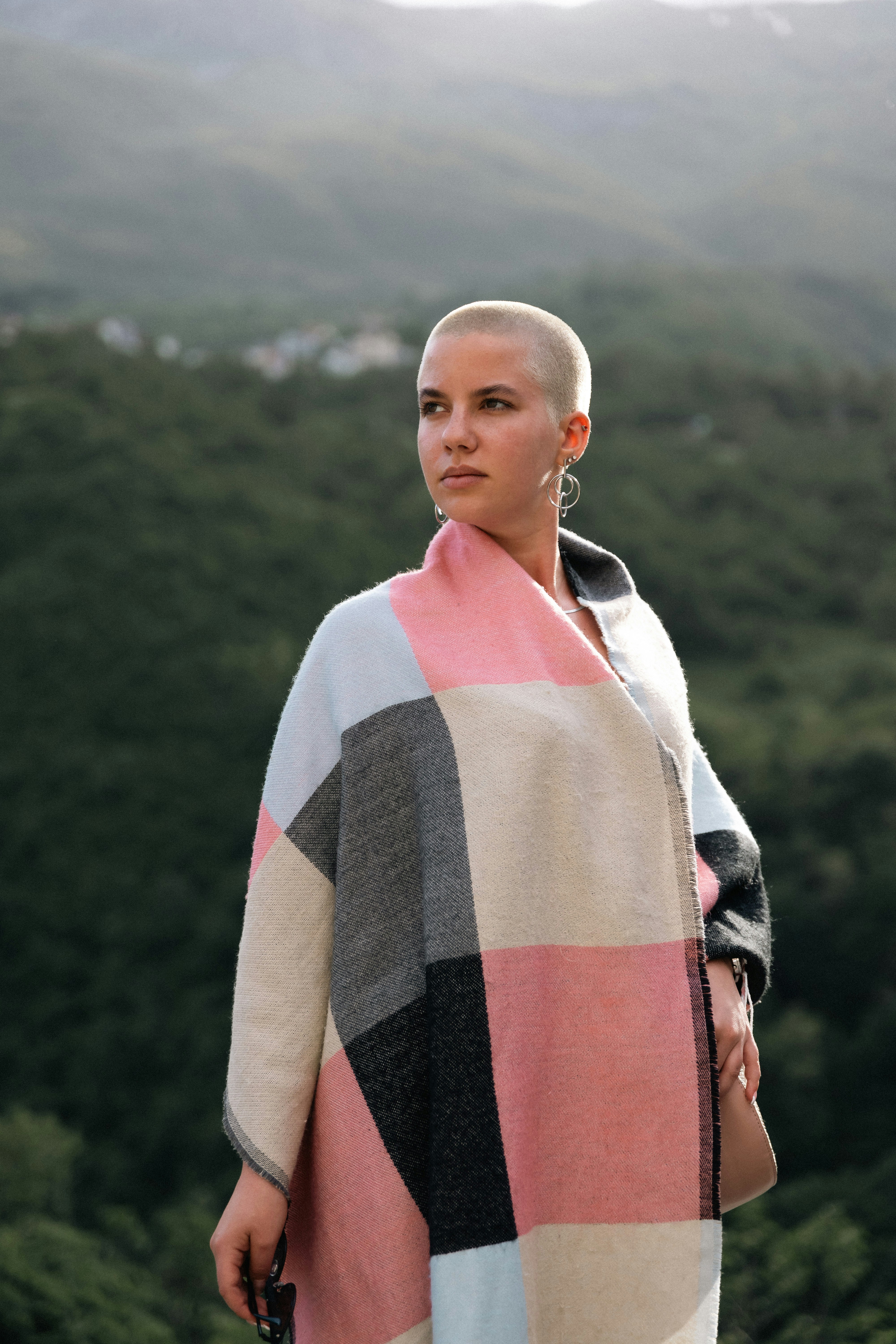 A woman with a shaved head is wrapped in a blanket photo – Free ...