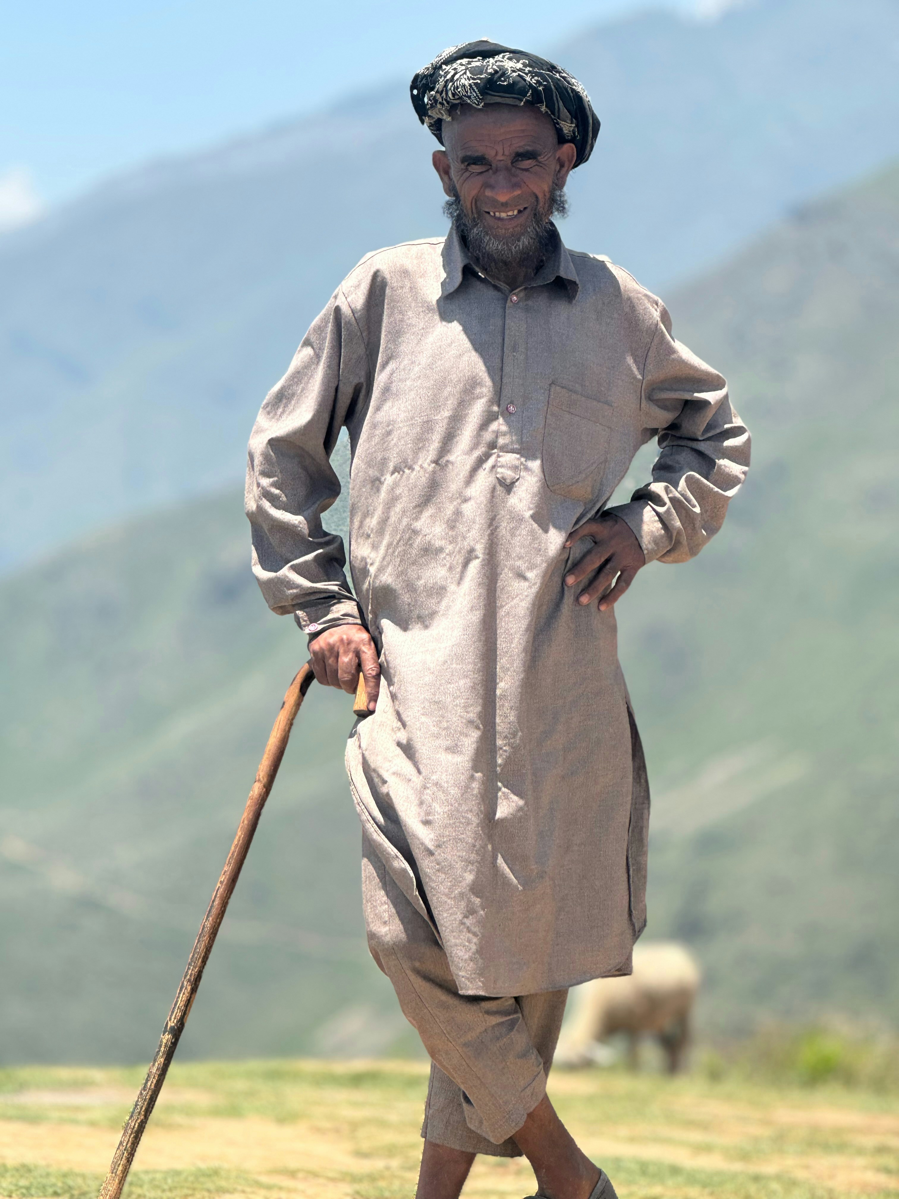 Stance of the Summit: A Weathered Herdsman in a Sunlit Mountain Pasture