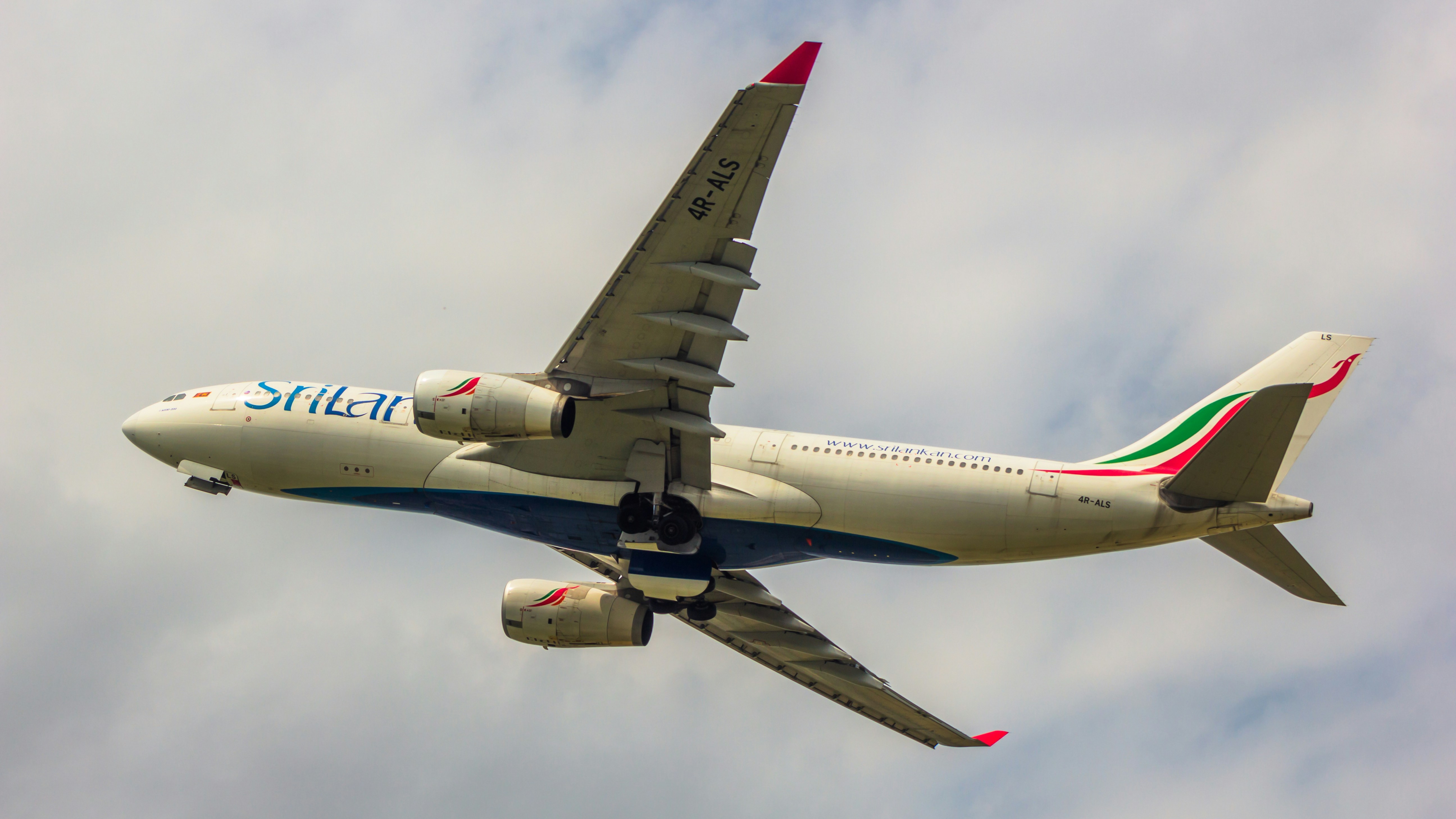 A large passenger jet flying through a cloudy sky photo – Free Aircraft ...