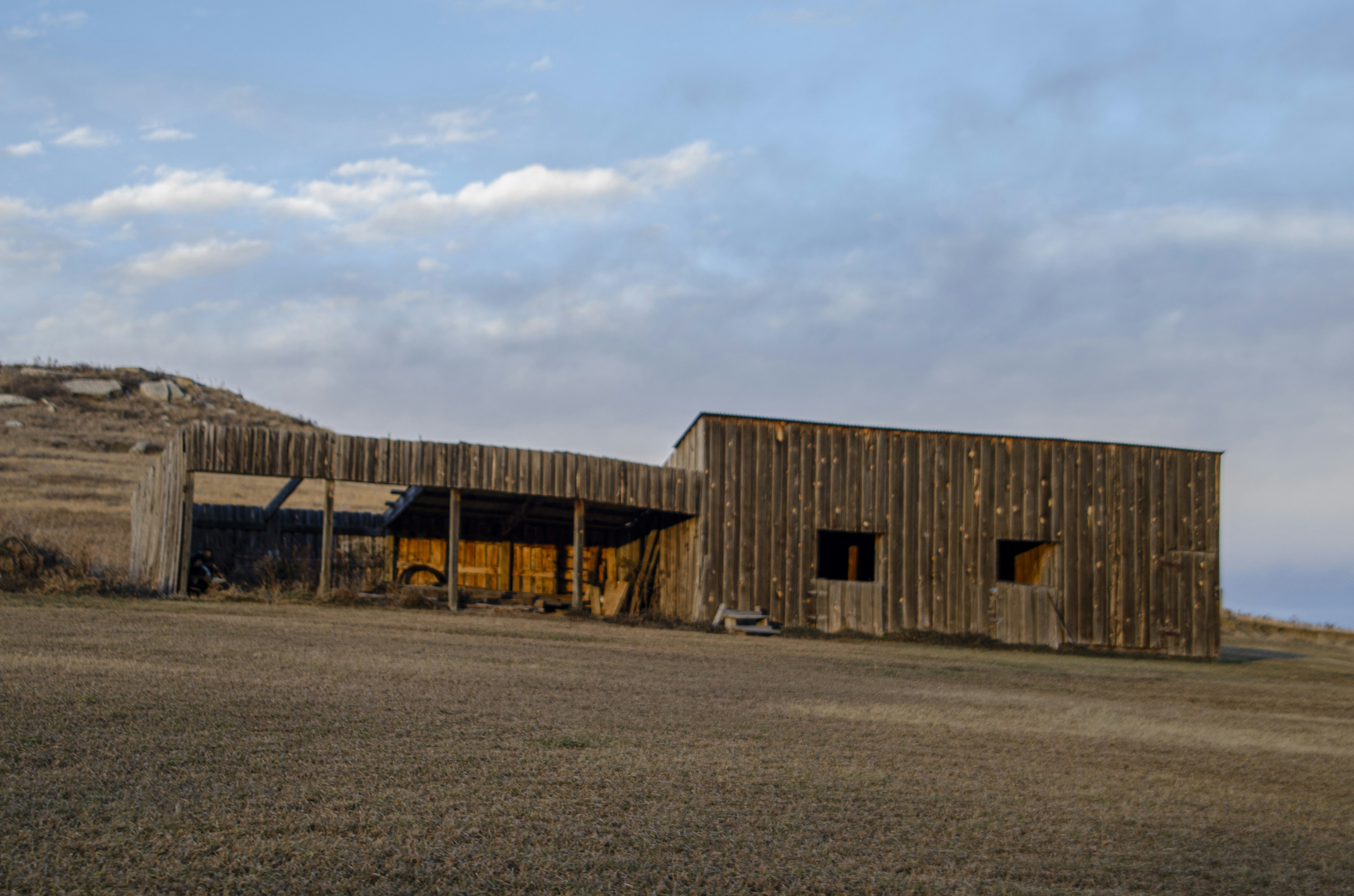 Weathered Timber Shed on a Quiet Prairie Under a Wide Sky