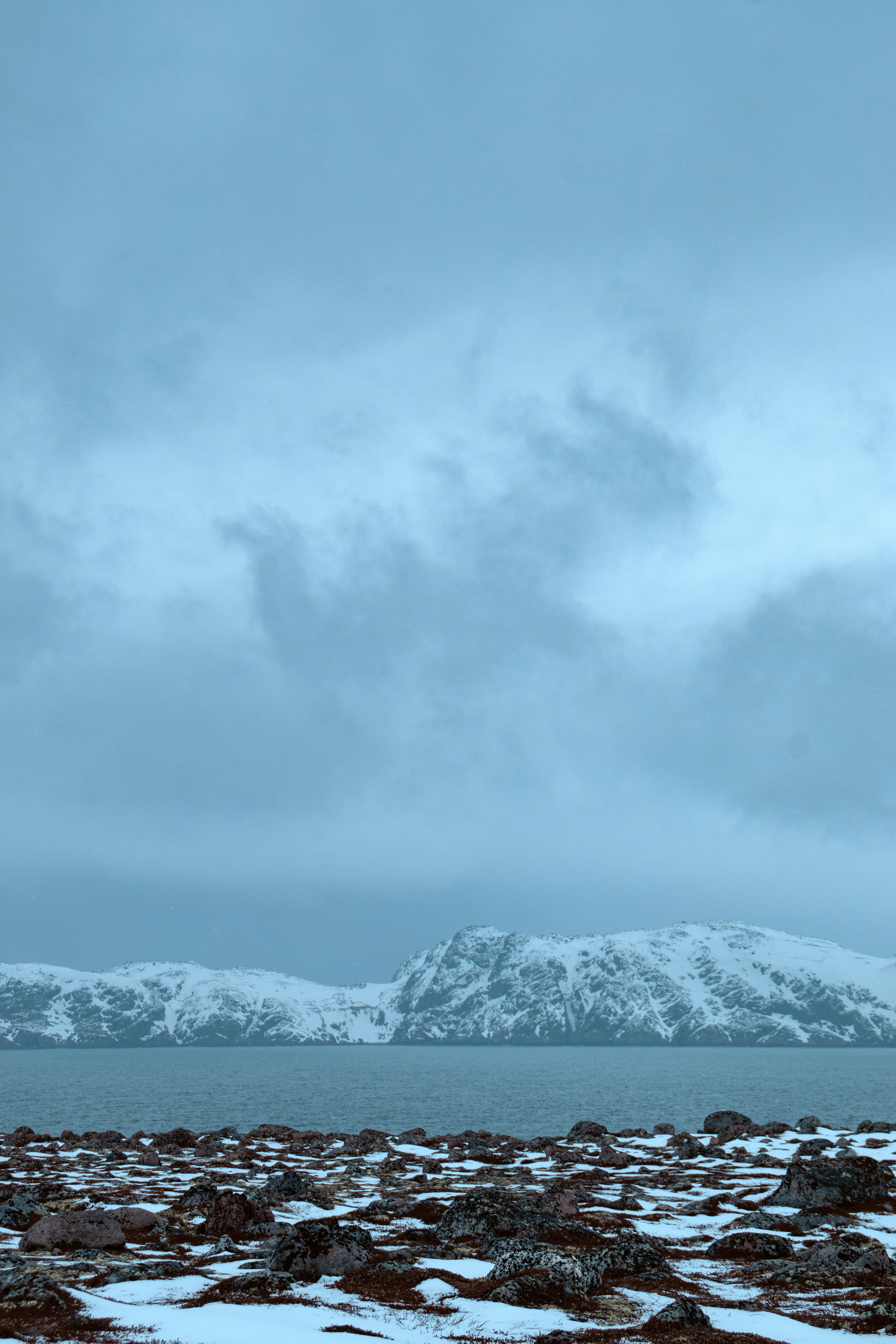 Blue Hour over Snow-Kissed Ridge: A Rugged Coastal Calm