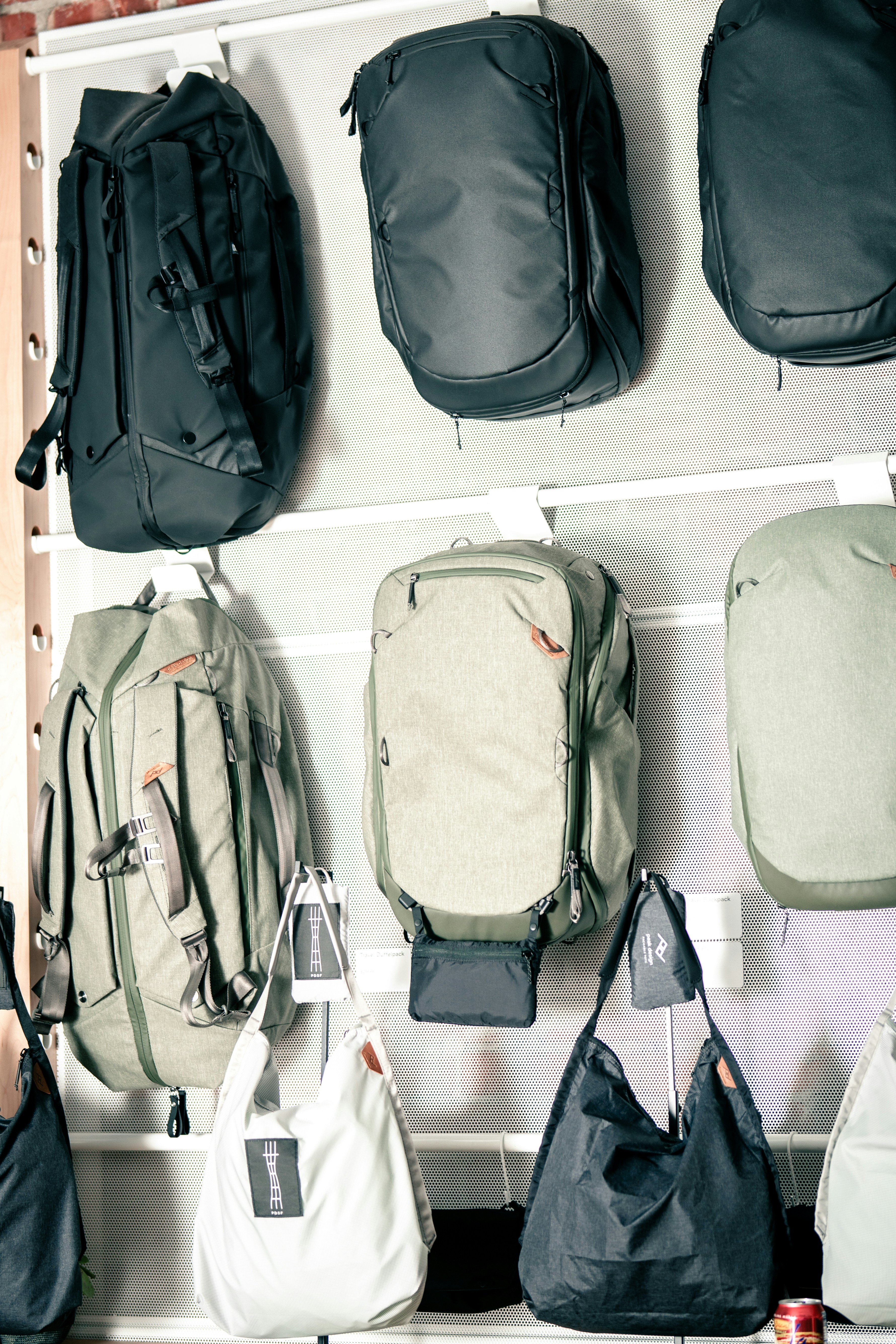 A bunch of backpacks hanging on a wall photo – Free Human Image on Unsplash