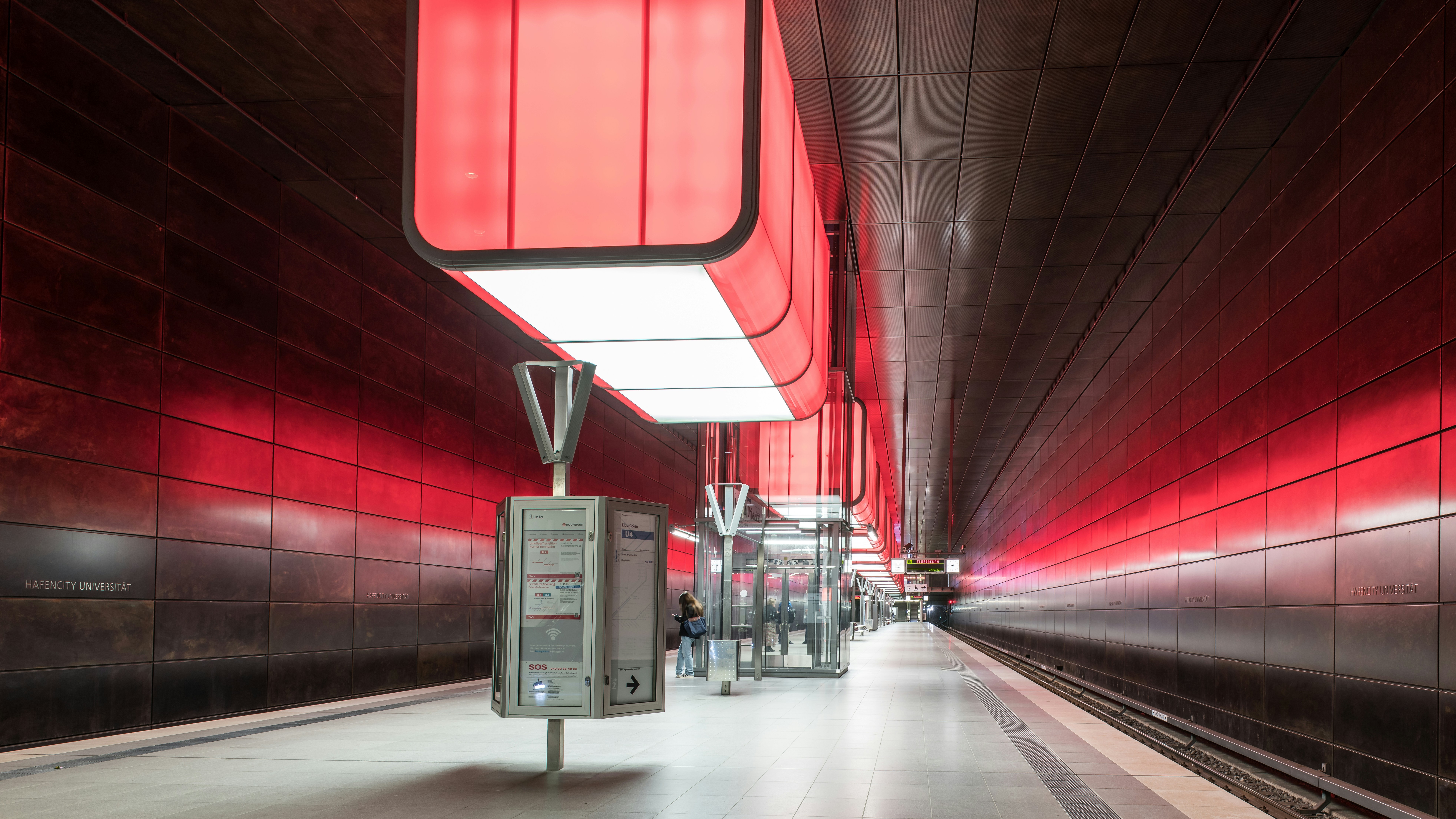 A subway station with a red light on the ceiling photo – Free Human ...