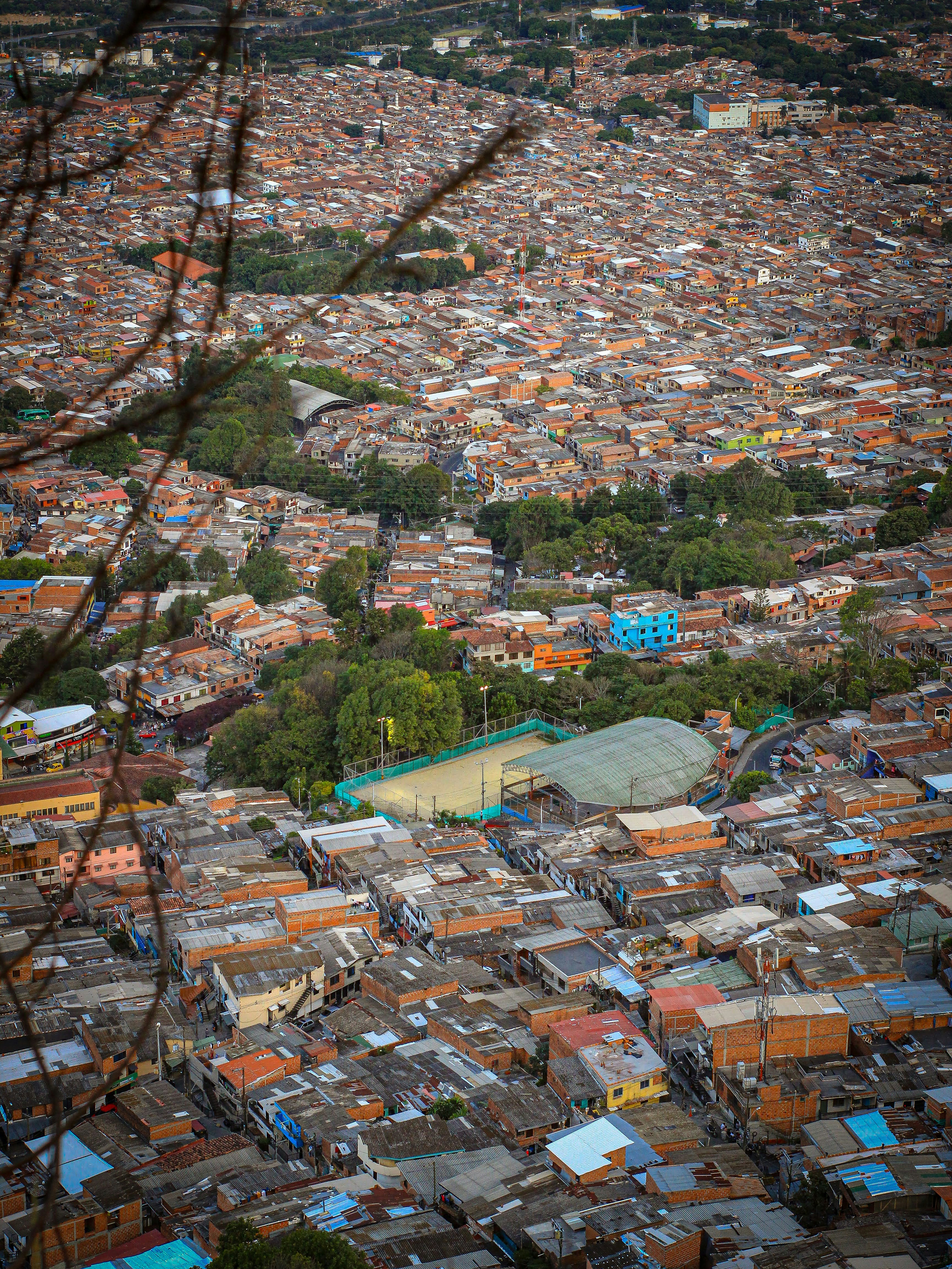 Terracotta Roofscape Surrounds a Hidden Green Stadium