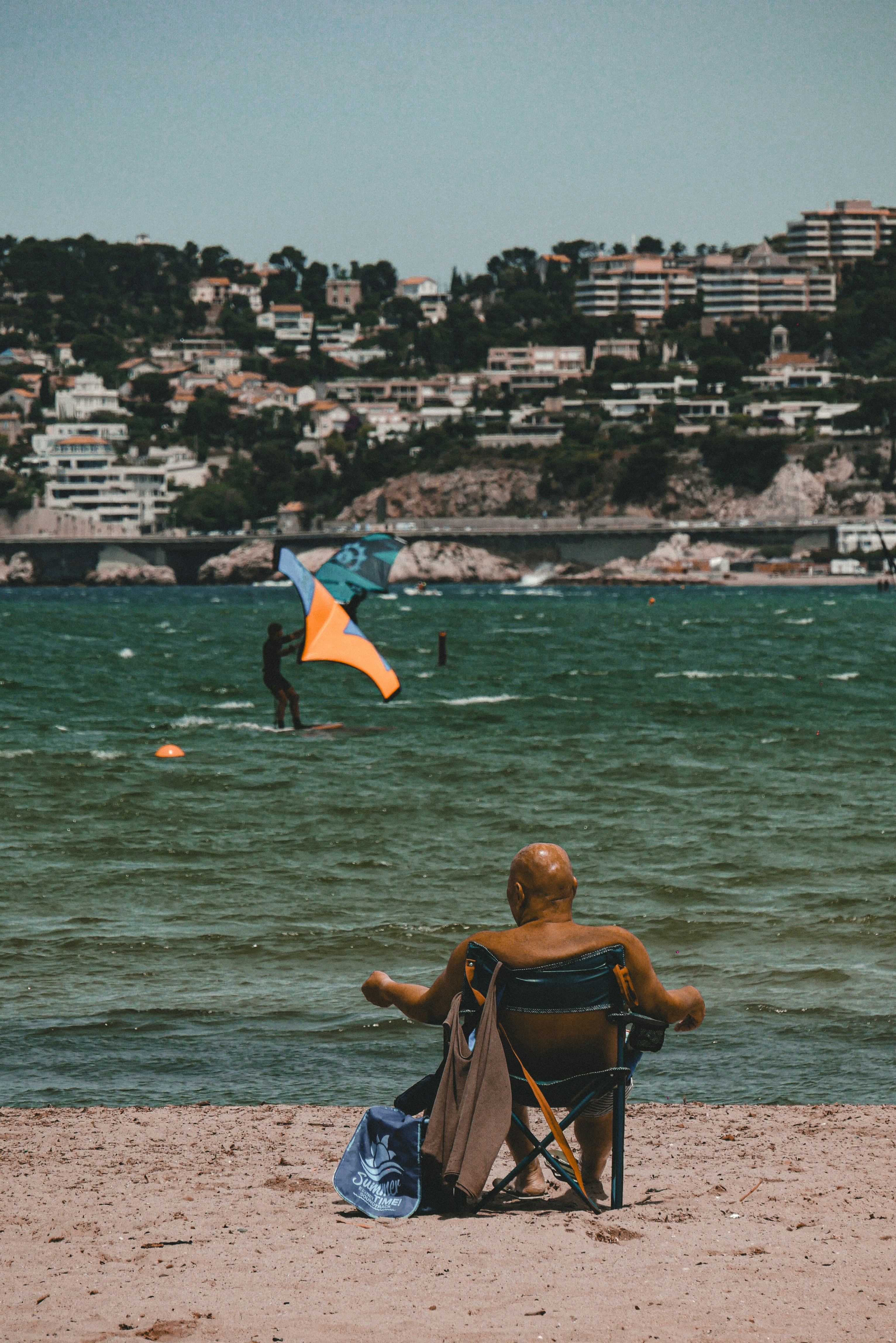 Solitary Beachgoer at the Quiet Edge of the City