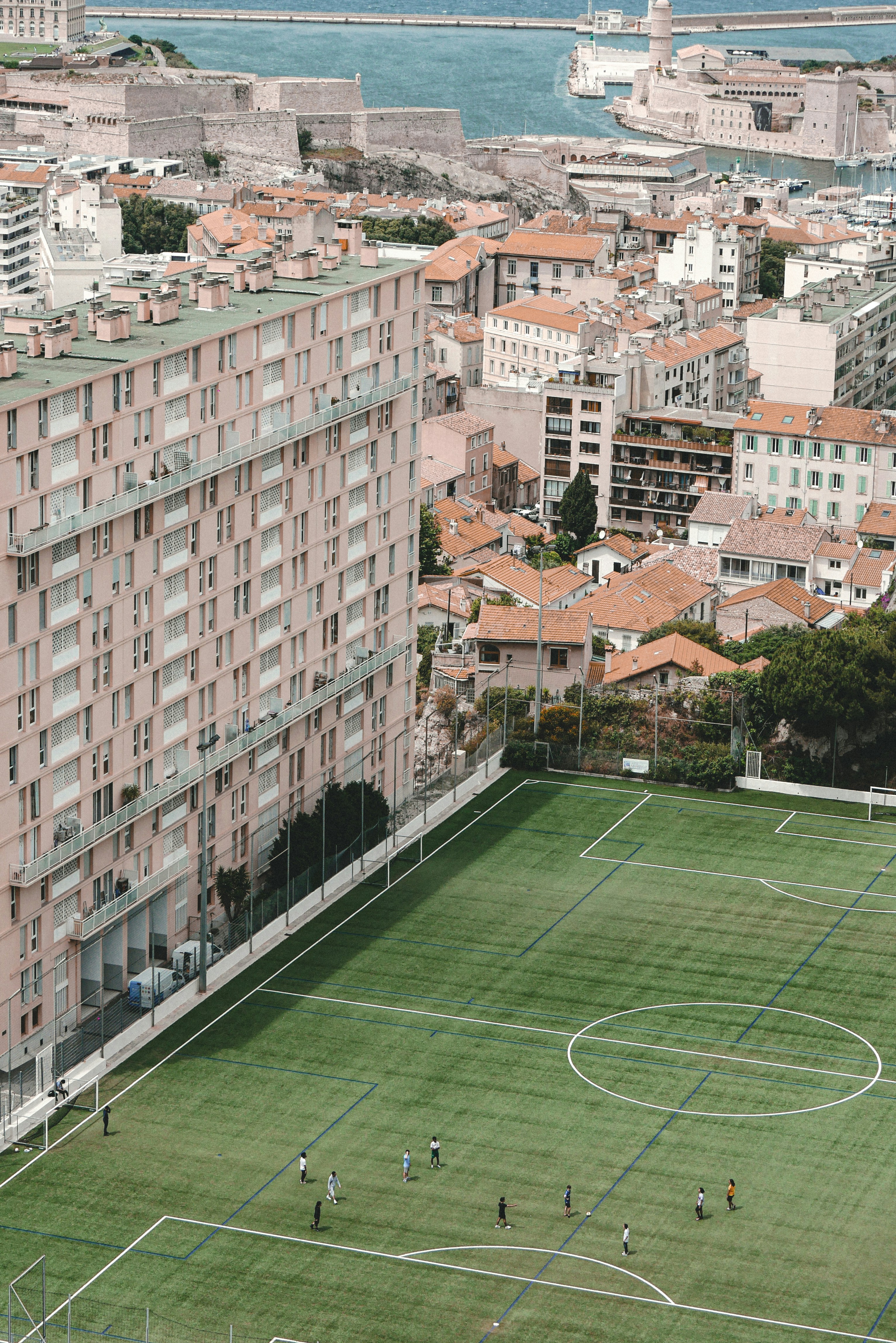 Pastel Towers Over a Playful Pitch: A Cityscape From Above