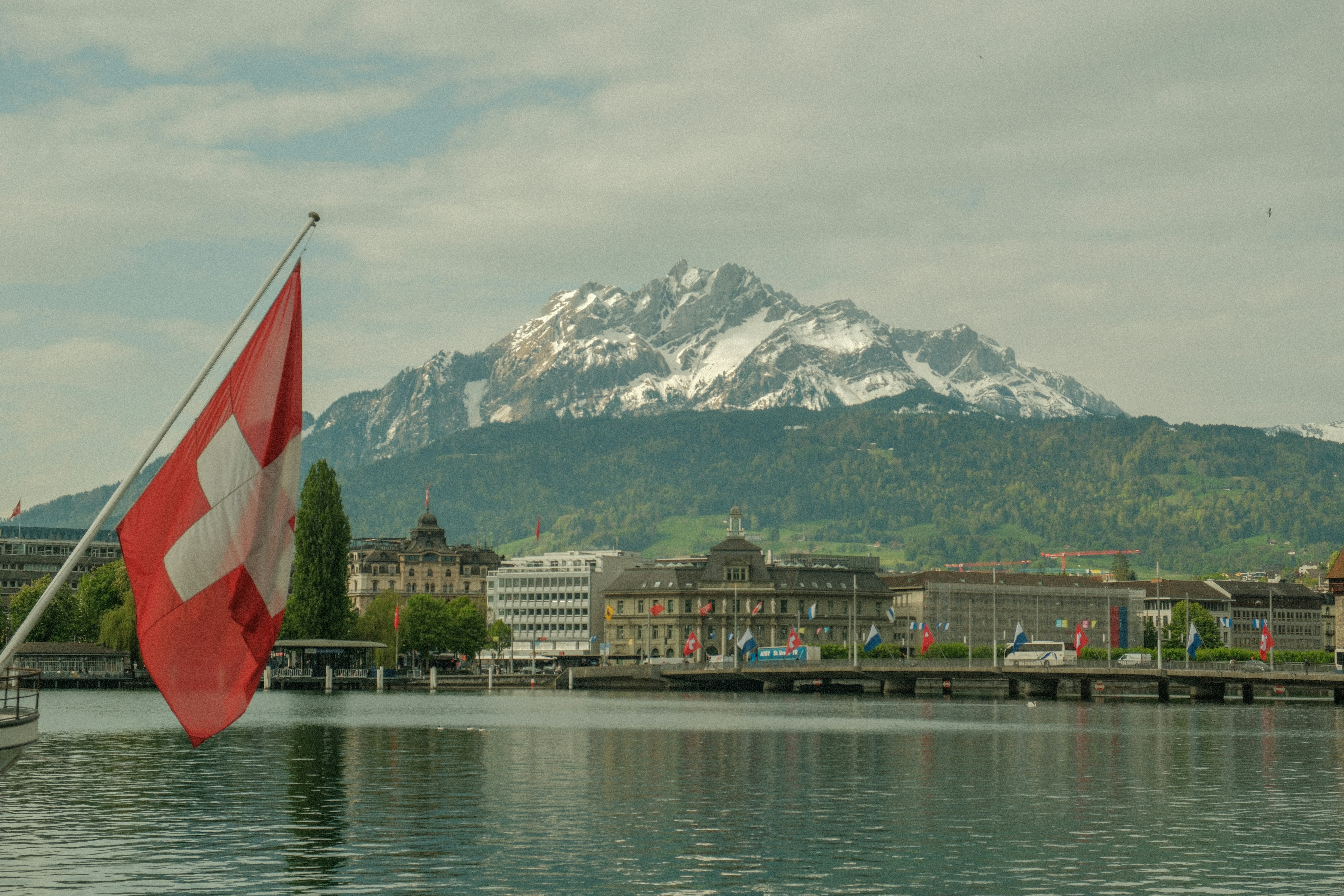 Flag on the Lakefront with Alpine Backdrop