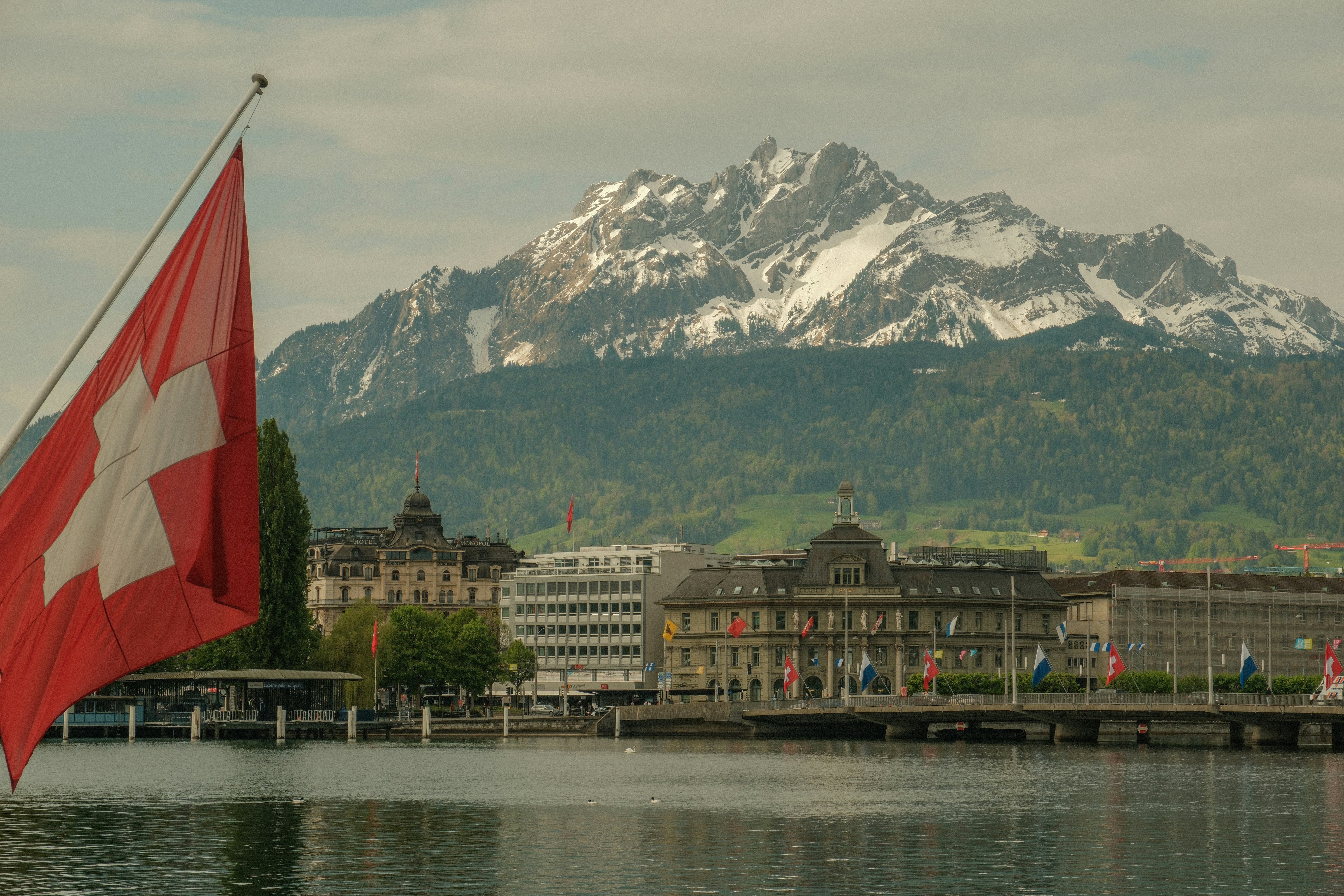 A swiss flag flying in front of a mountain photo – Free Switzerland ...