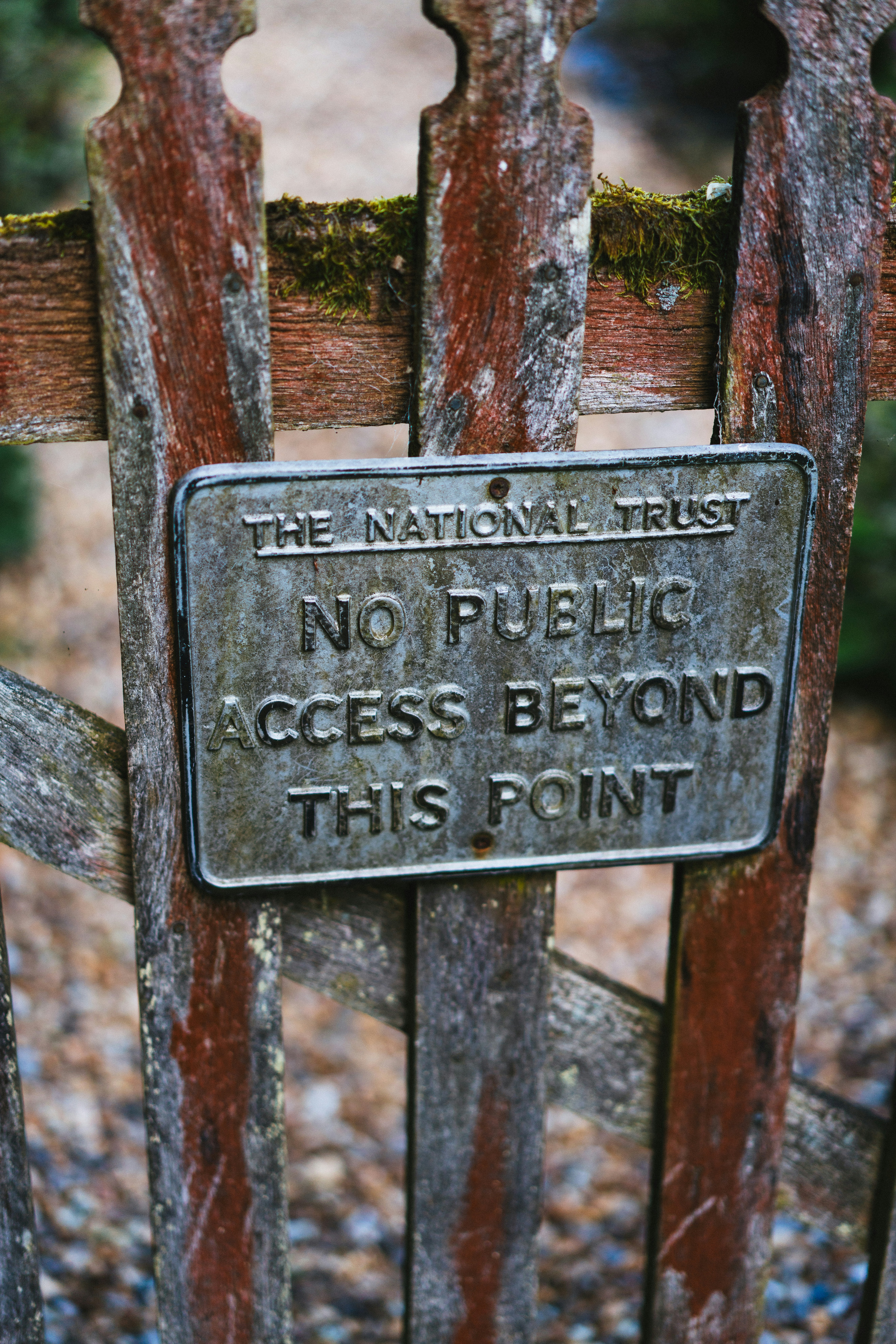 Weathered Iron Gate: The No Public Access Plaque at the Threshold