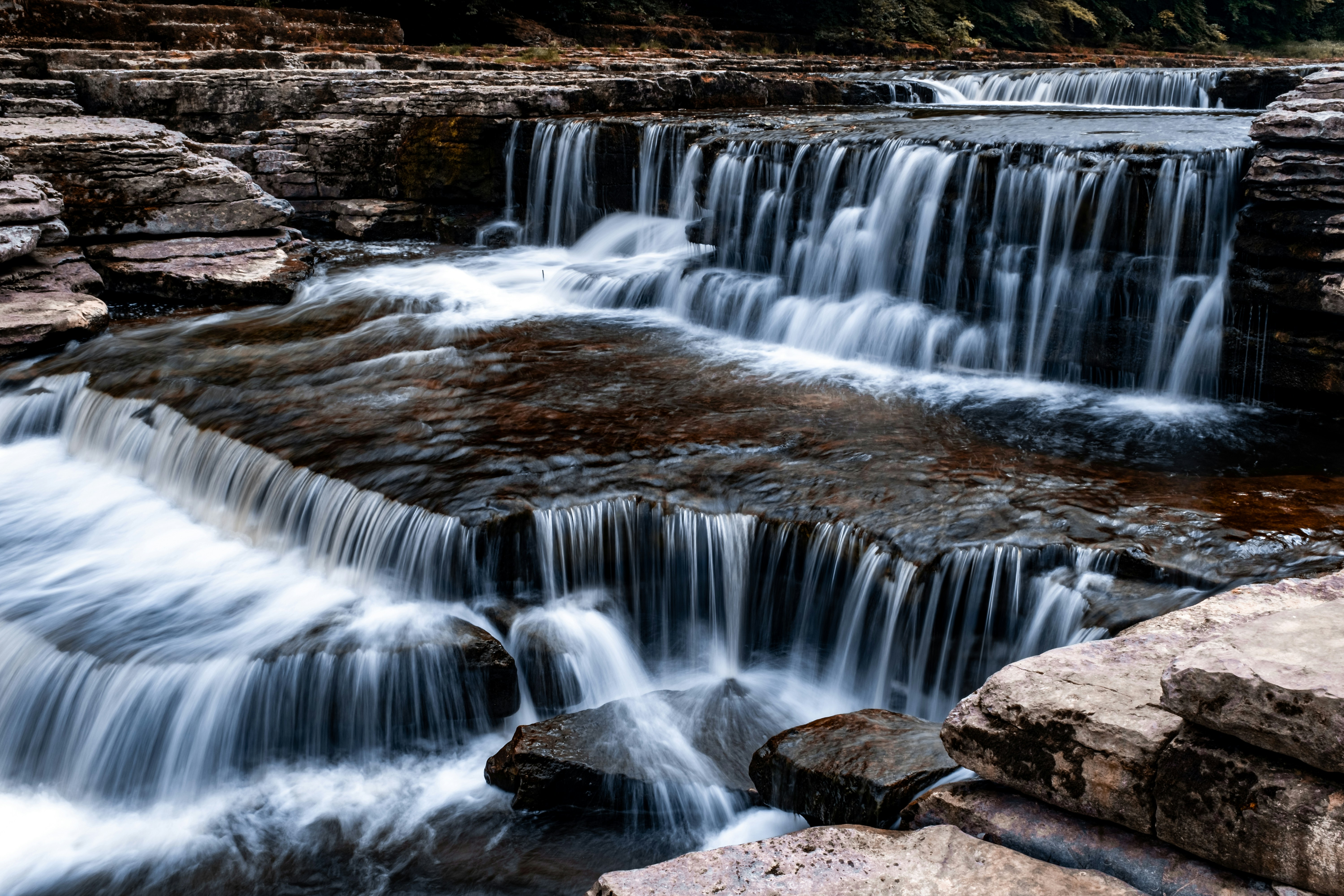 A large waterfall with lots of water coming out of it photo – Free ...