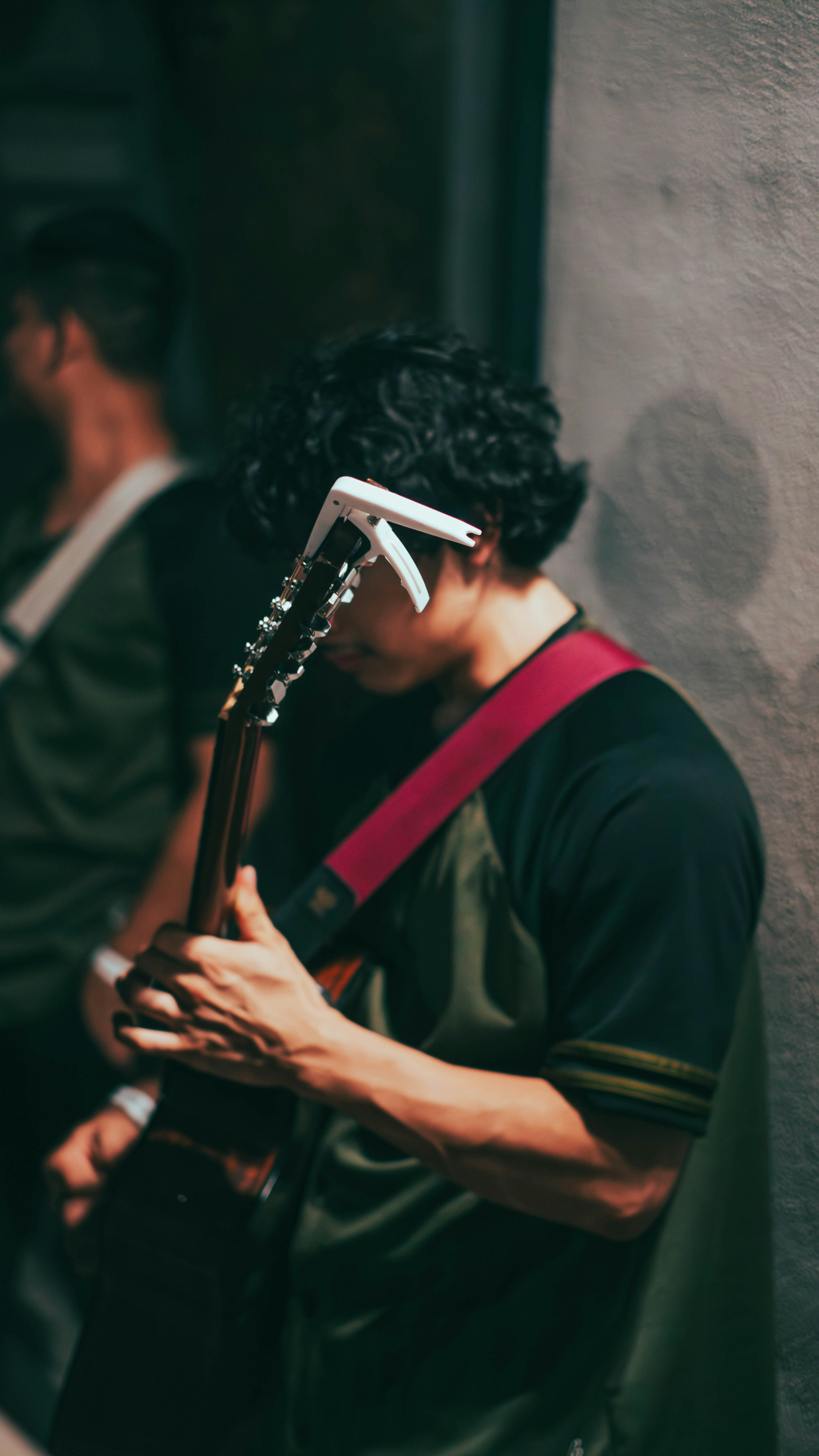 Concrete Echoes: A Guitarist in Soft Focus by the Alley Wall