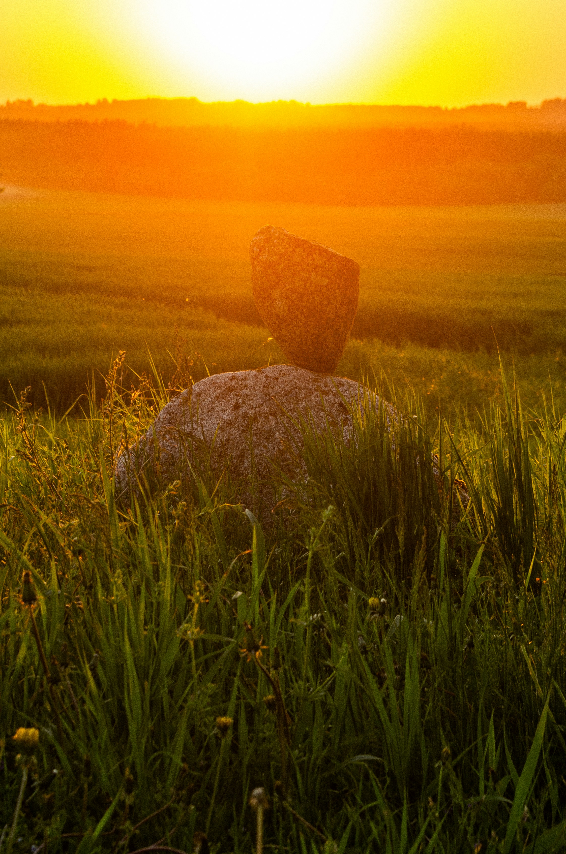 Cairn of Fire: A Stone Stack in a Grassland Sunset