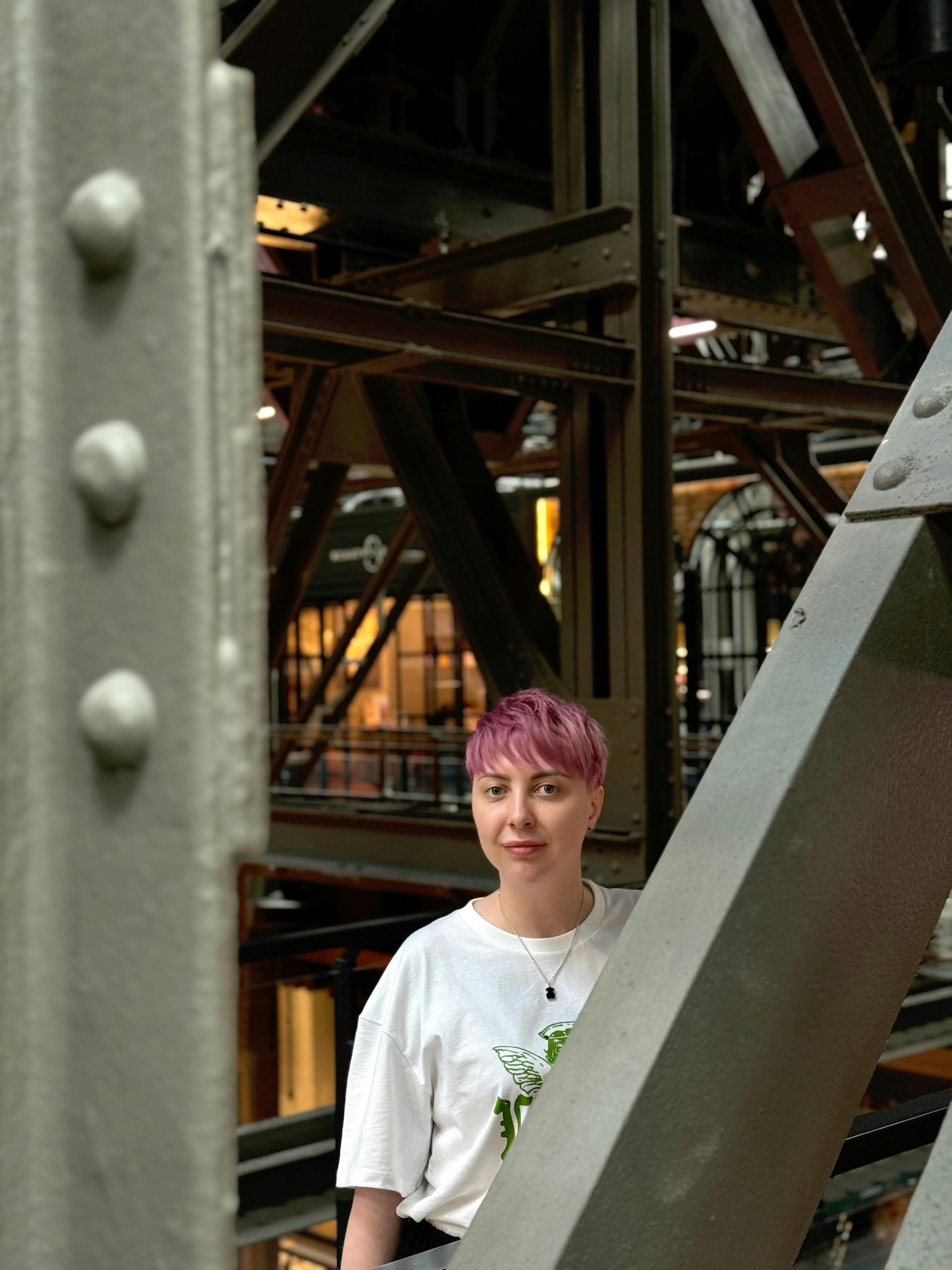 Crimson Locks Amid Industrial Geometry: Portrait in a Steel Forest