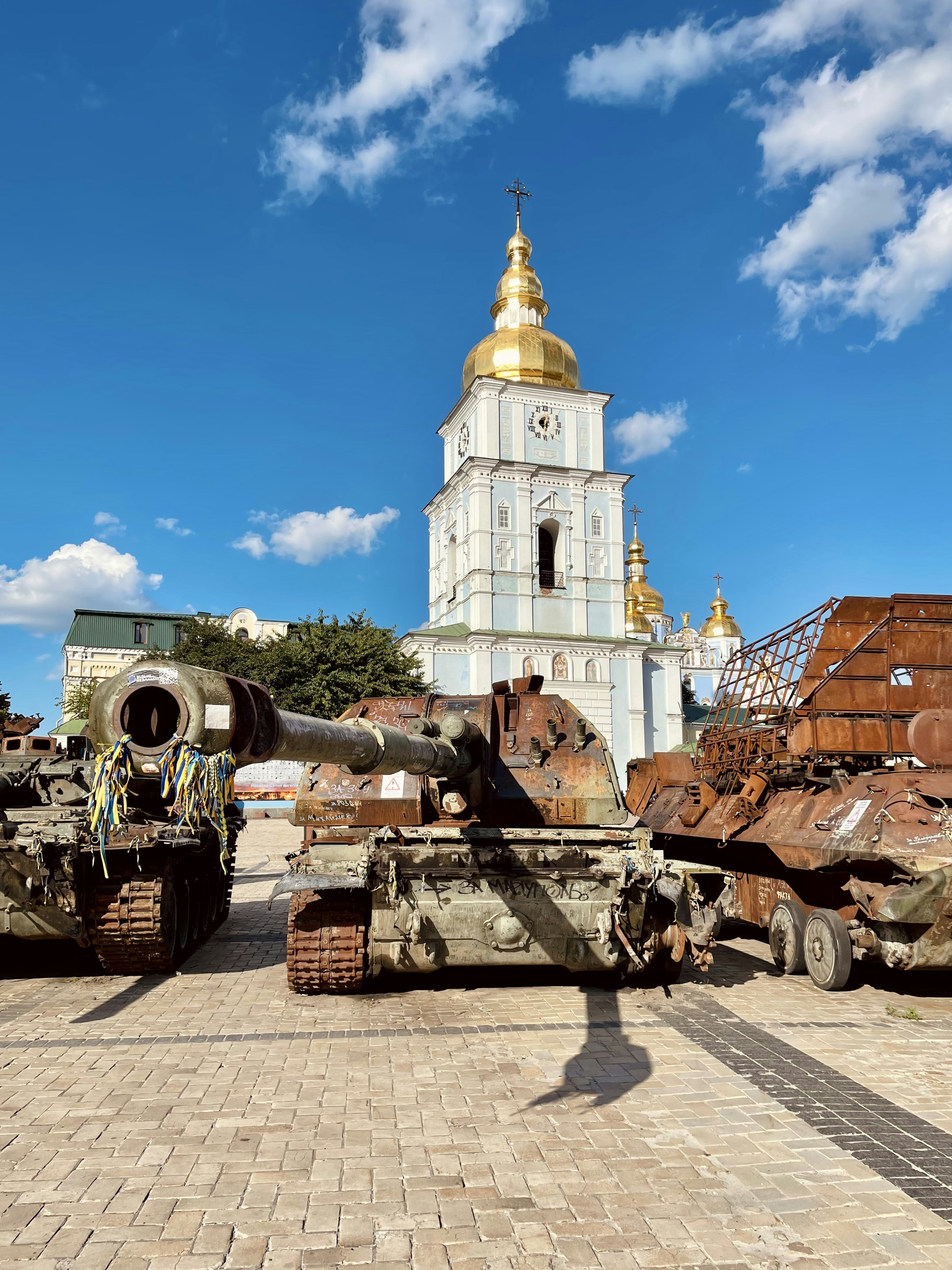 Armor on the Plaza: Rusted Tanks Meet a Golden-Domed Cathedral
