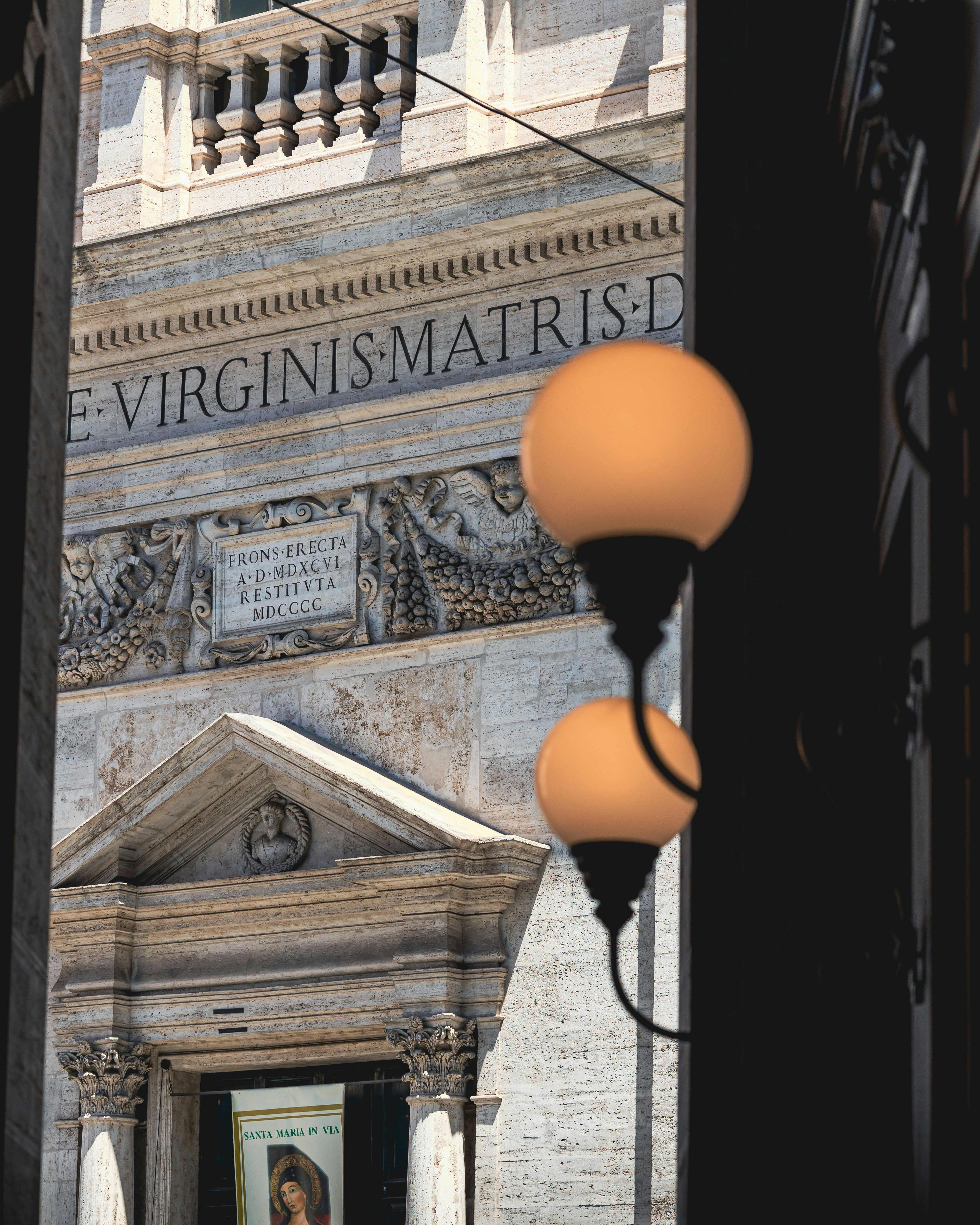 Streetside Cathedral Glass: Lanterns Flanking a Historic Façade