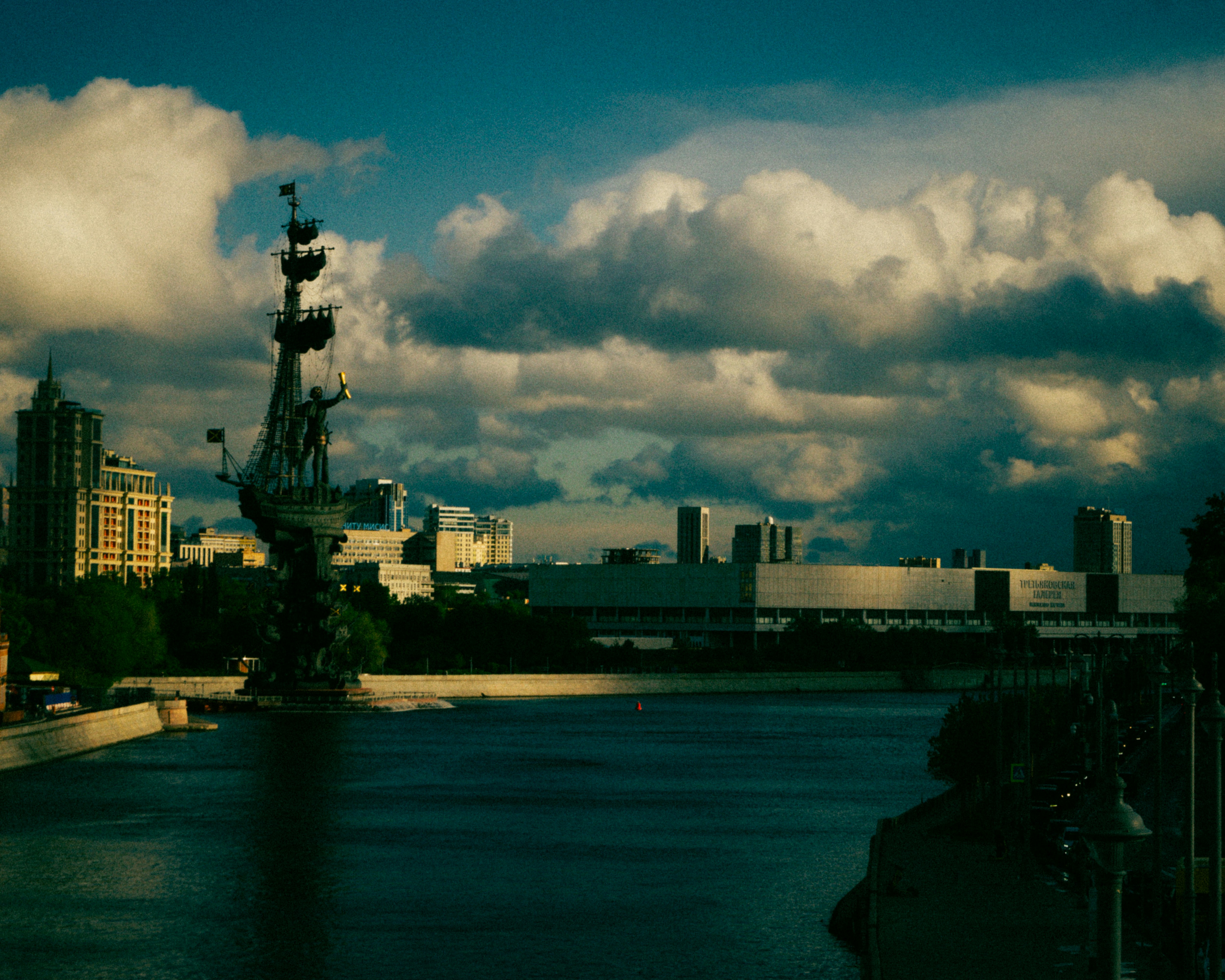 The River Guardian: A Landmark Silhouette Beside the Dusk-tinted Water