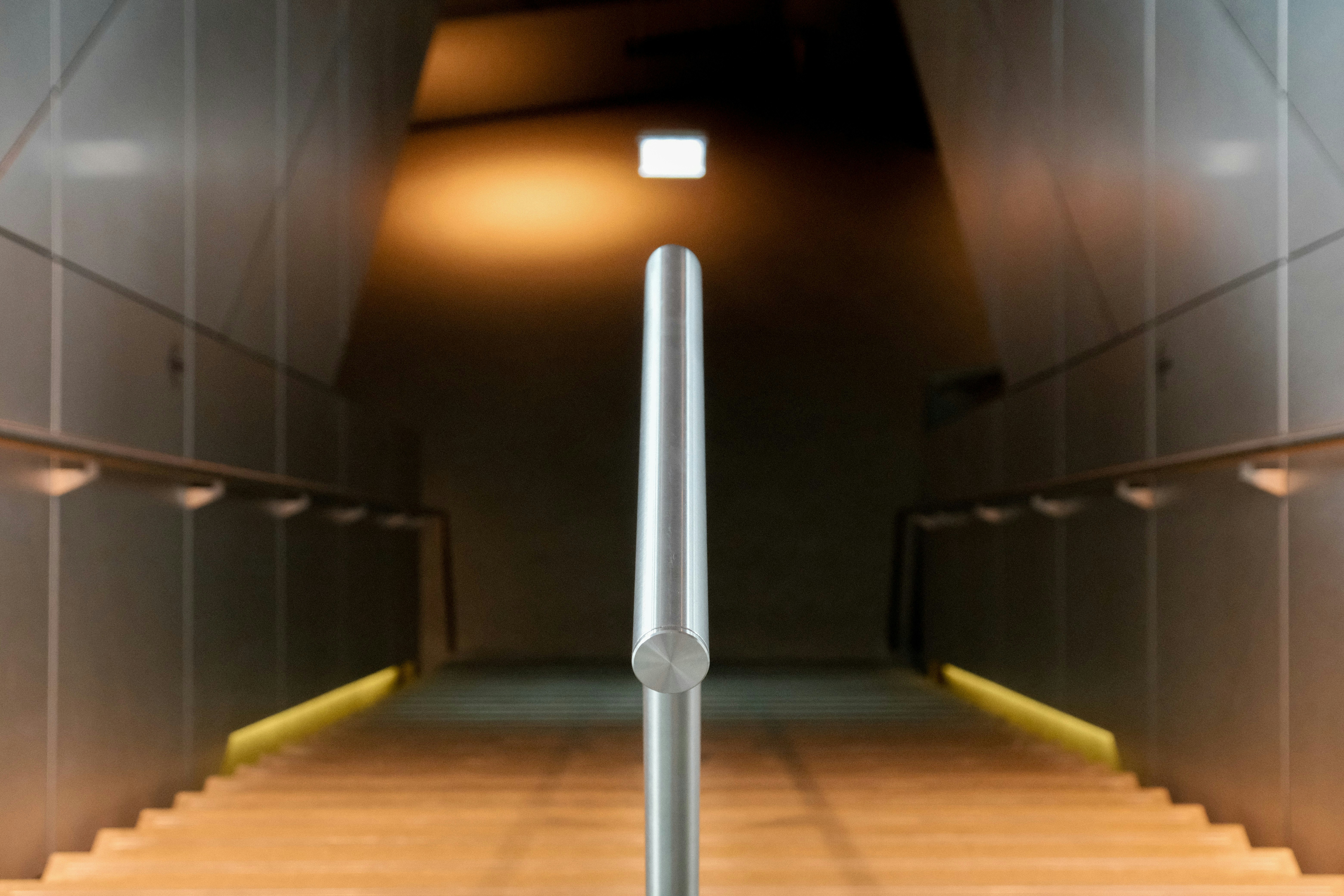 Rails to the Quiet Glow: A Symmetrical Stairwell in Perspective
