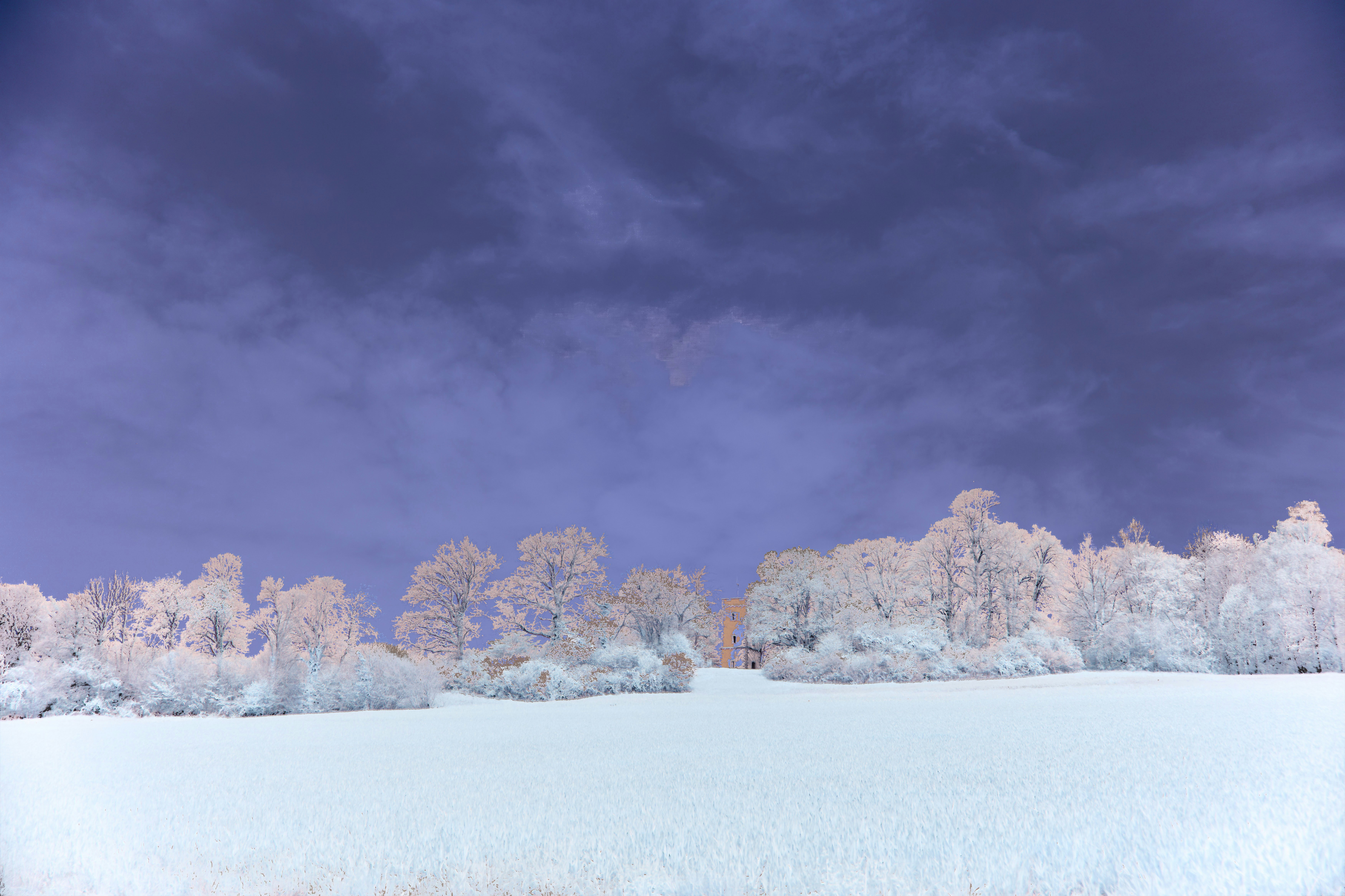 A snow covered field under a cloudy sky photo – Free Winter Image on ...
