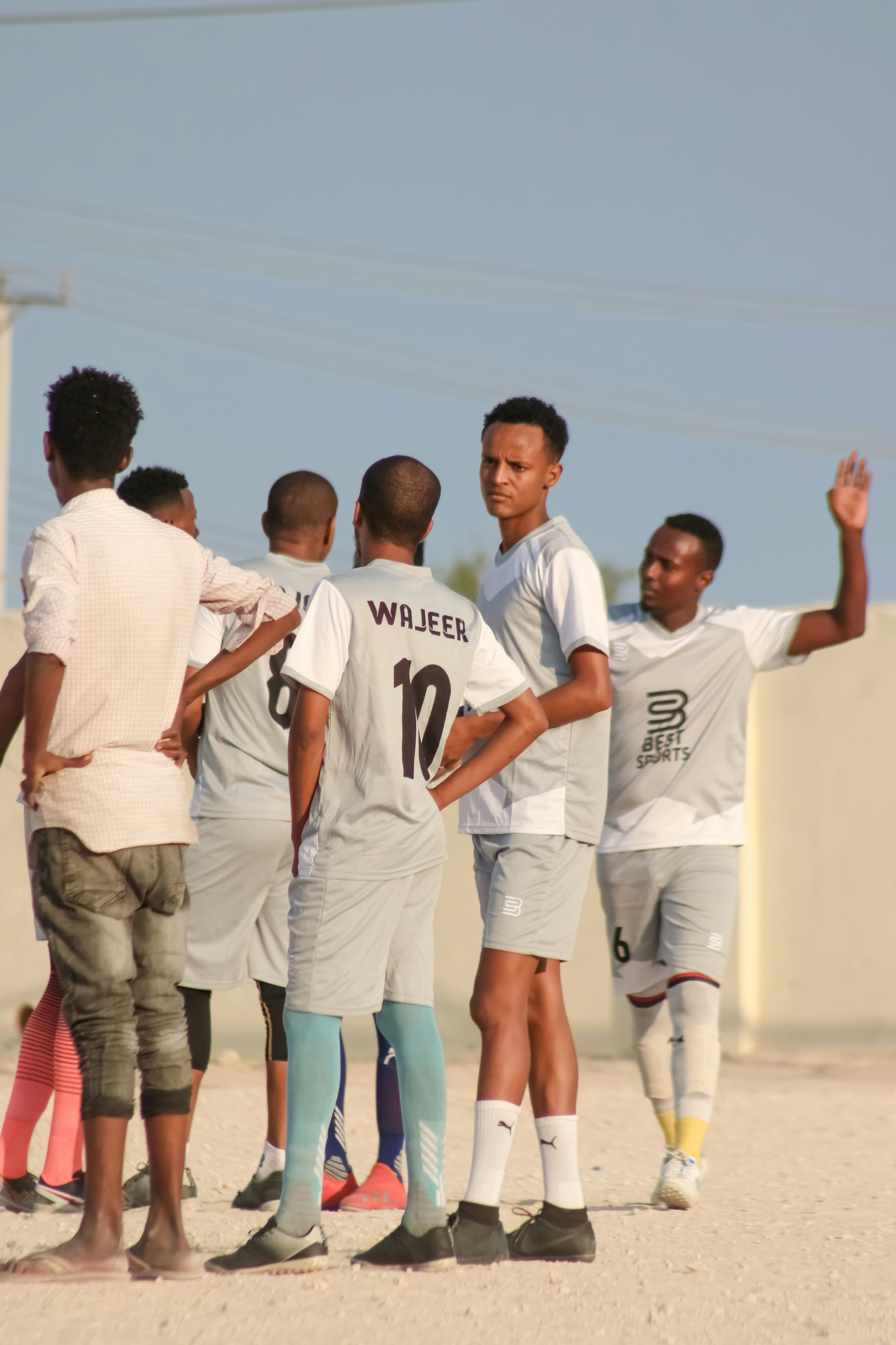 A group of young men standing around each other photo – Free Portrait ...