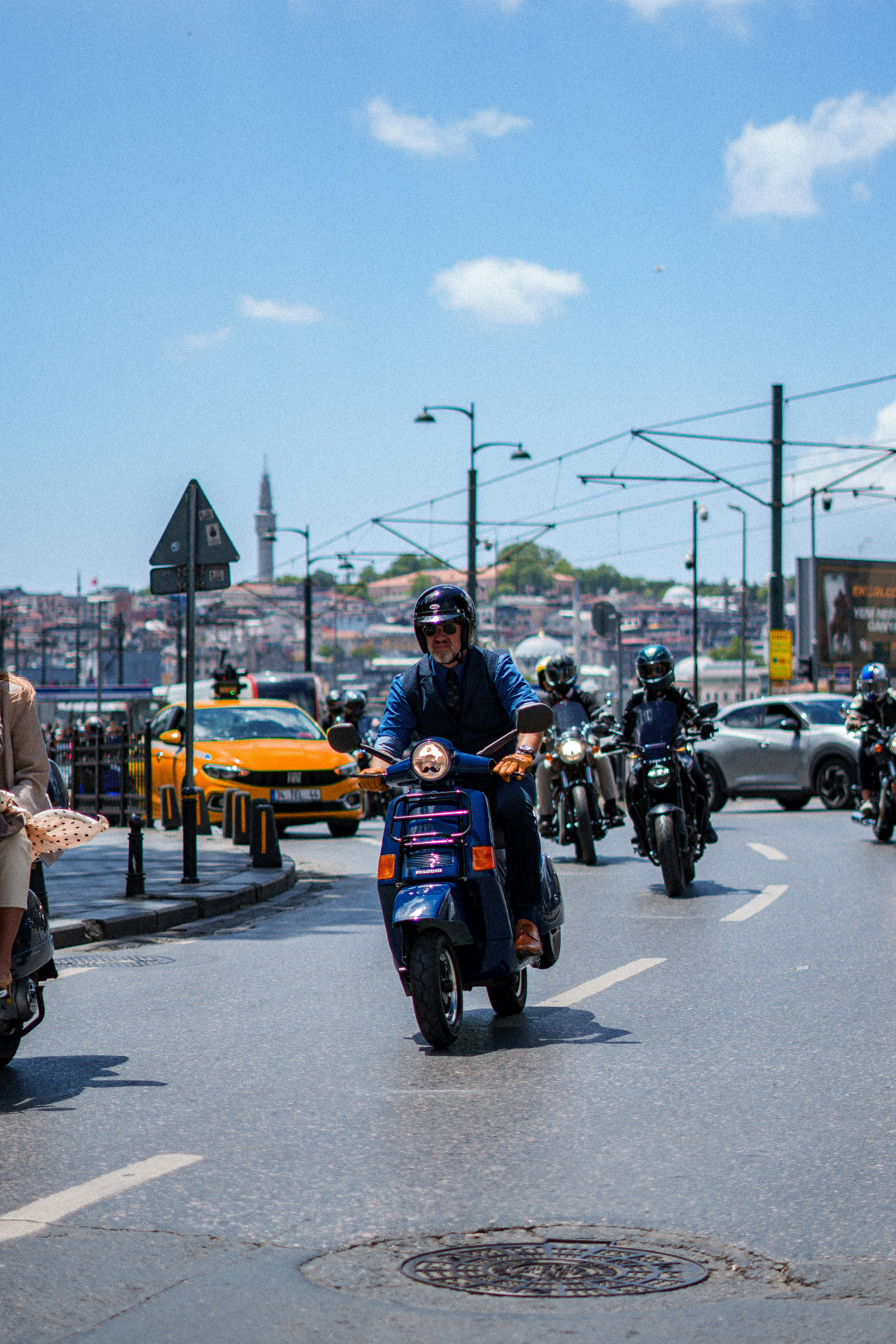 Blue-Sleeved Scooterist Commands a Busy Waterfront Street