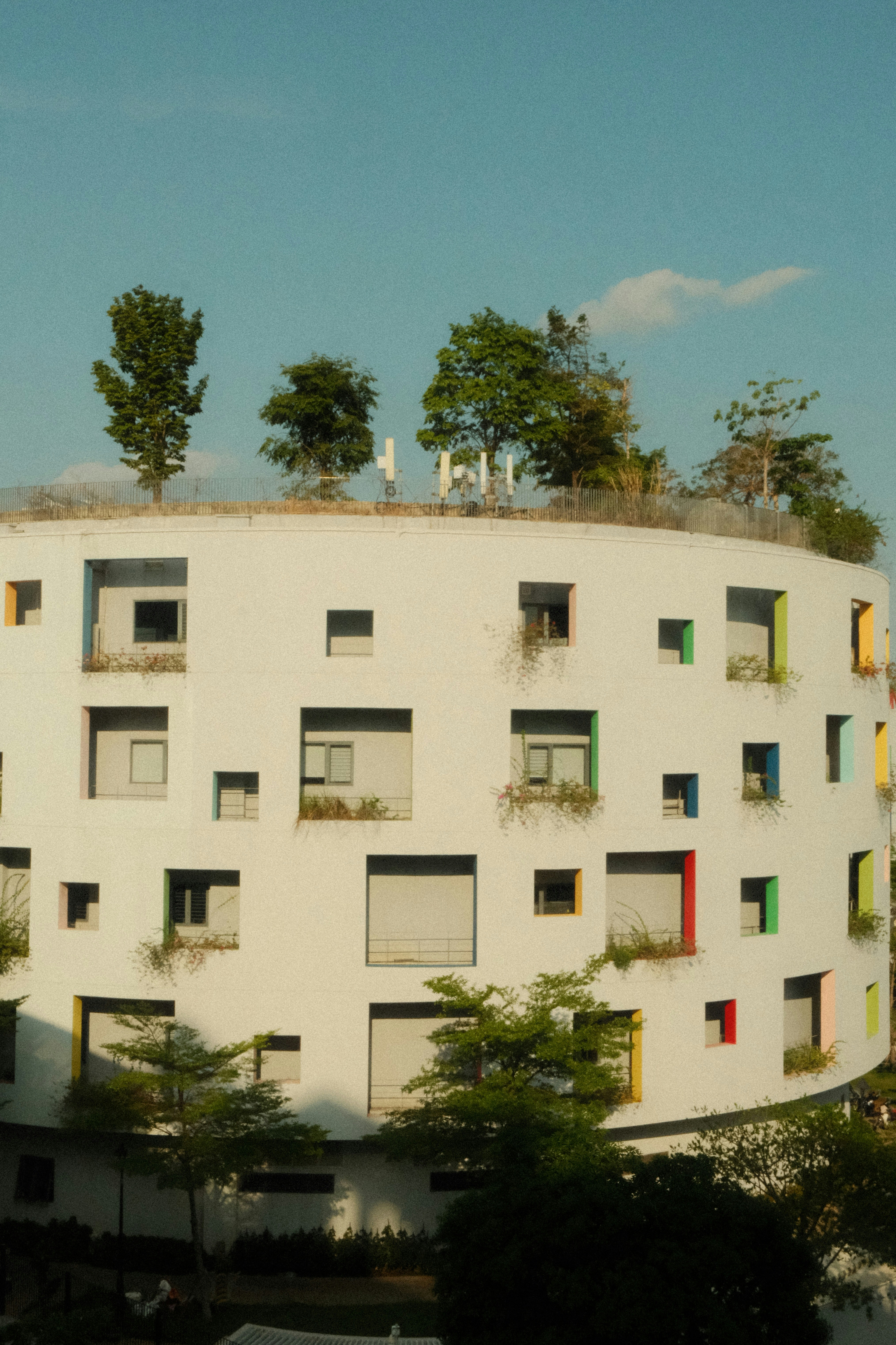 A white building with a bunch of windows on top of it photo – Free ...