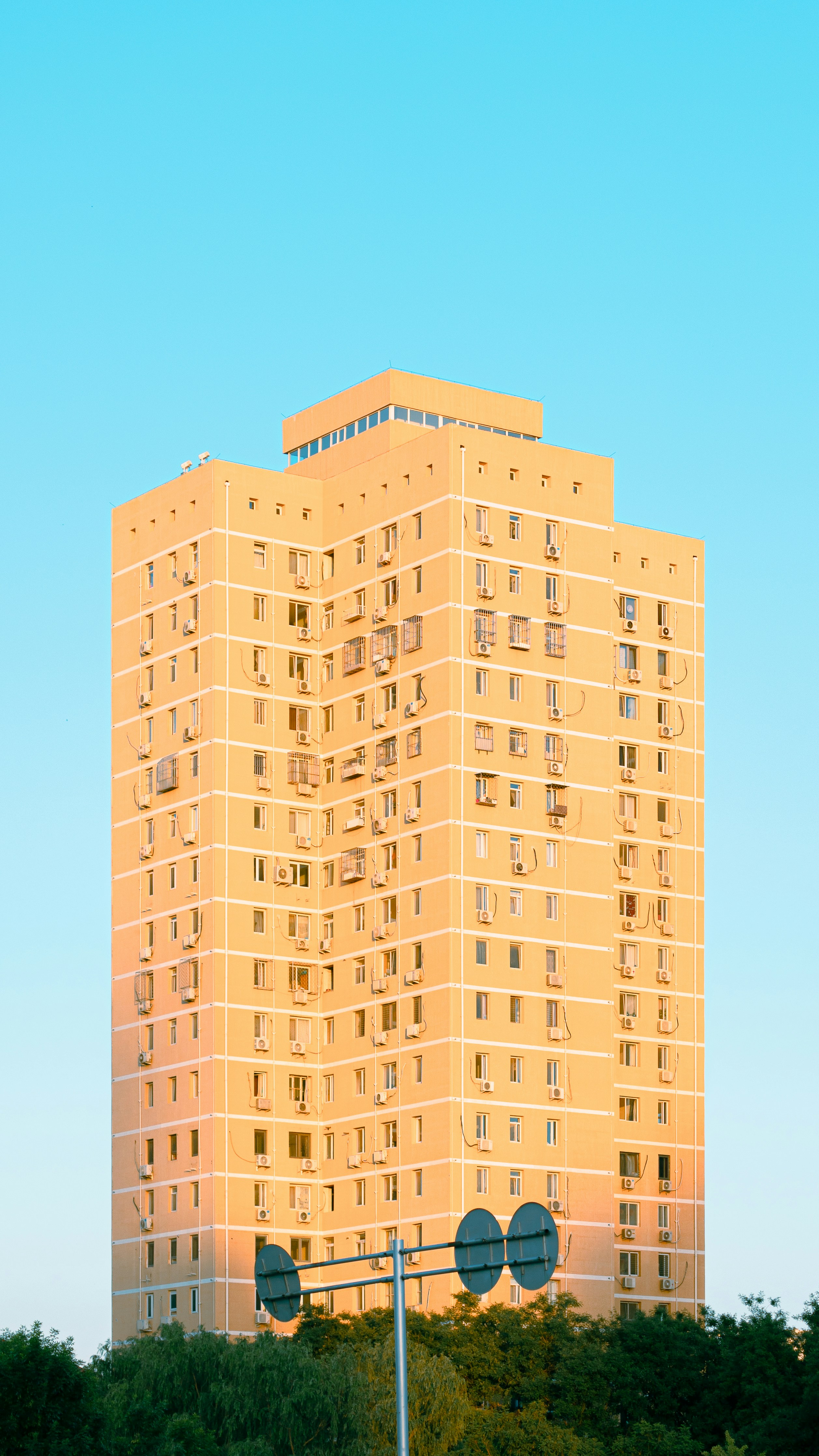 Peach-Tinted Highrise Reaching into a Clear Azure Sky