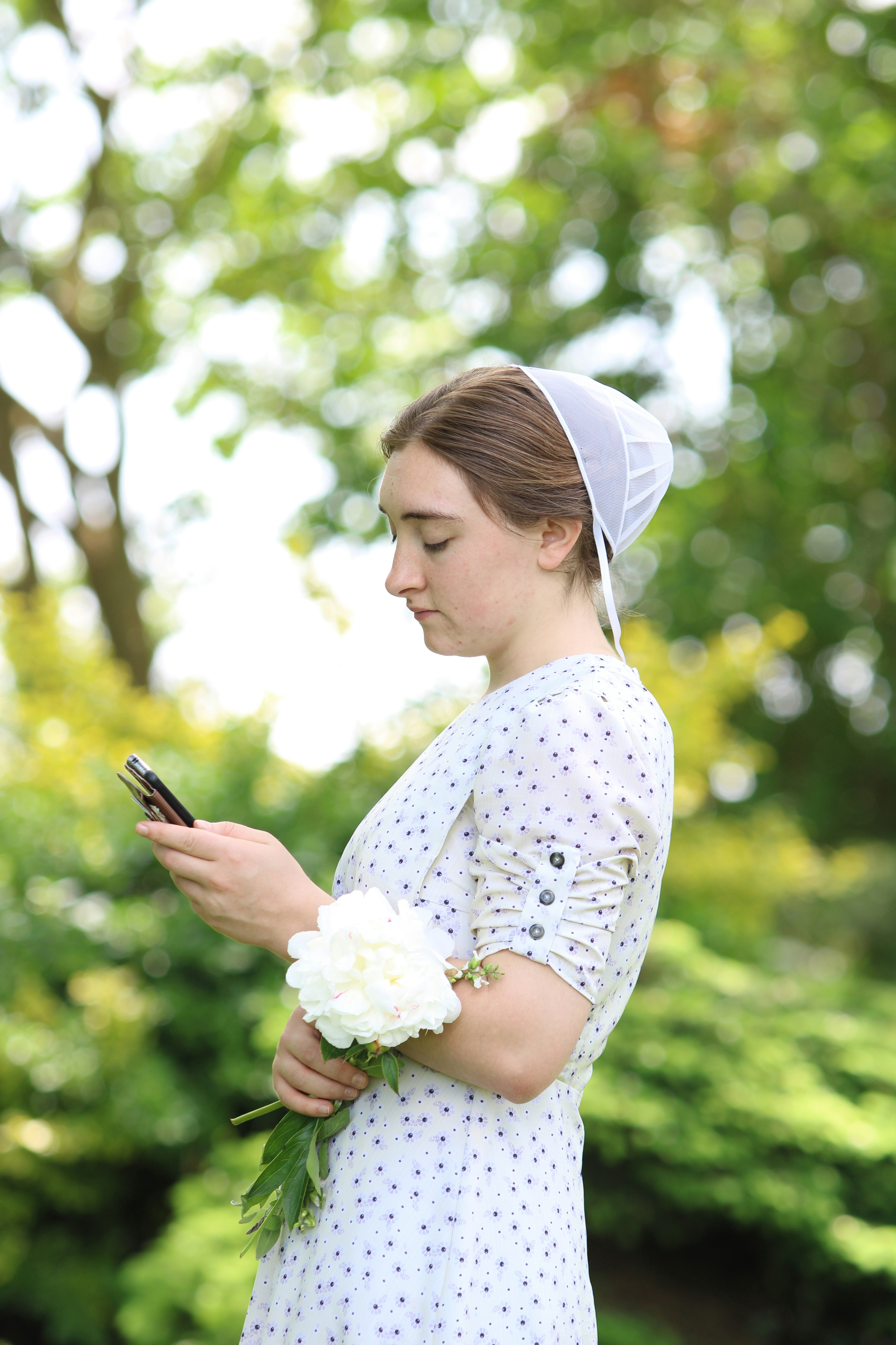 Soft-Garden Portrait: A Vintage Nurse in White Amid Greenery