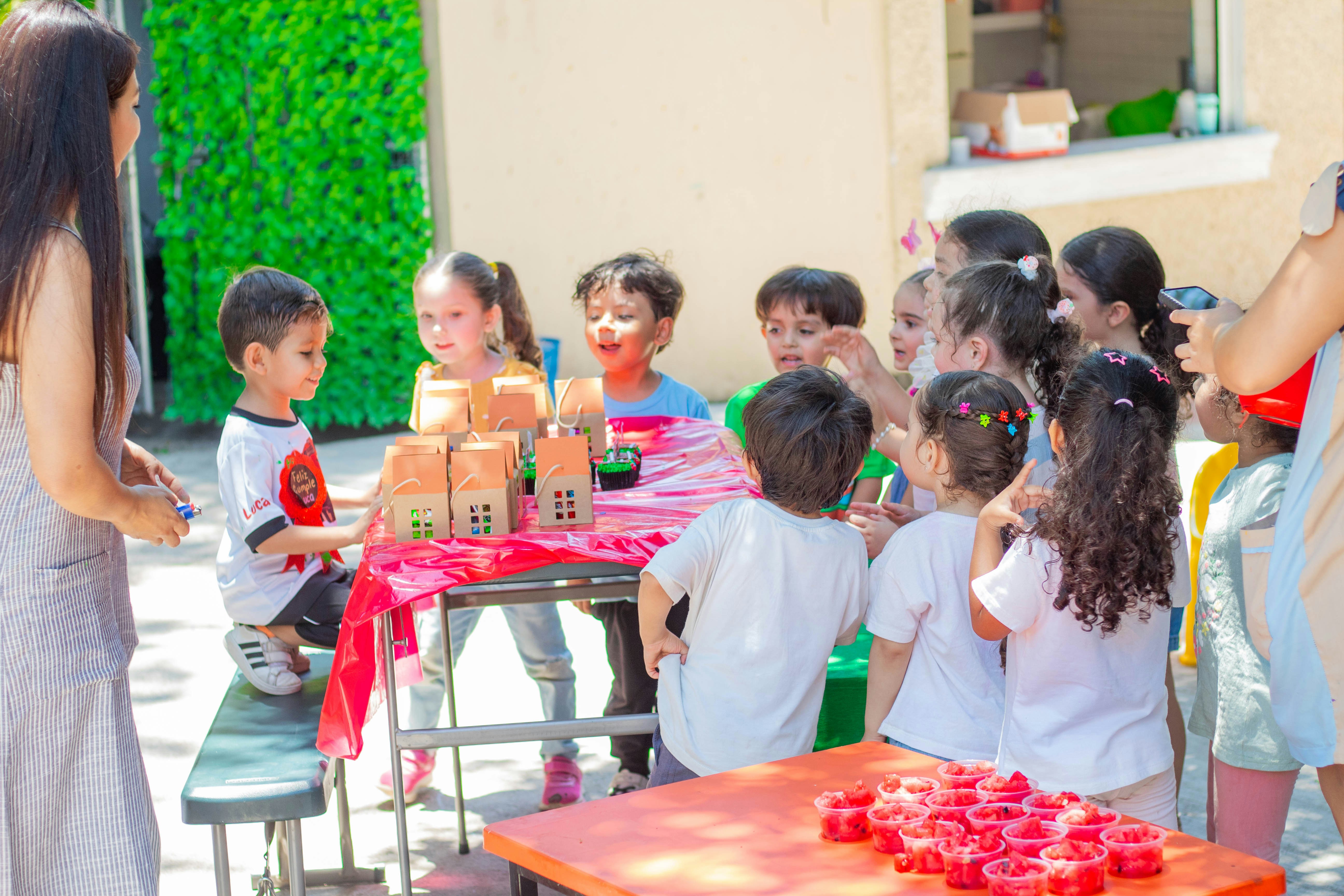 A group of children standing around a table photo – Free Human Image on ...