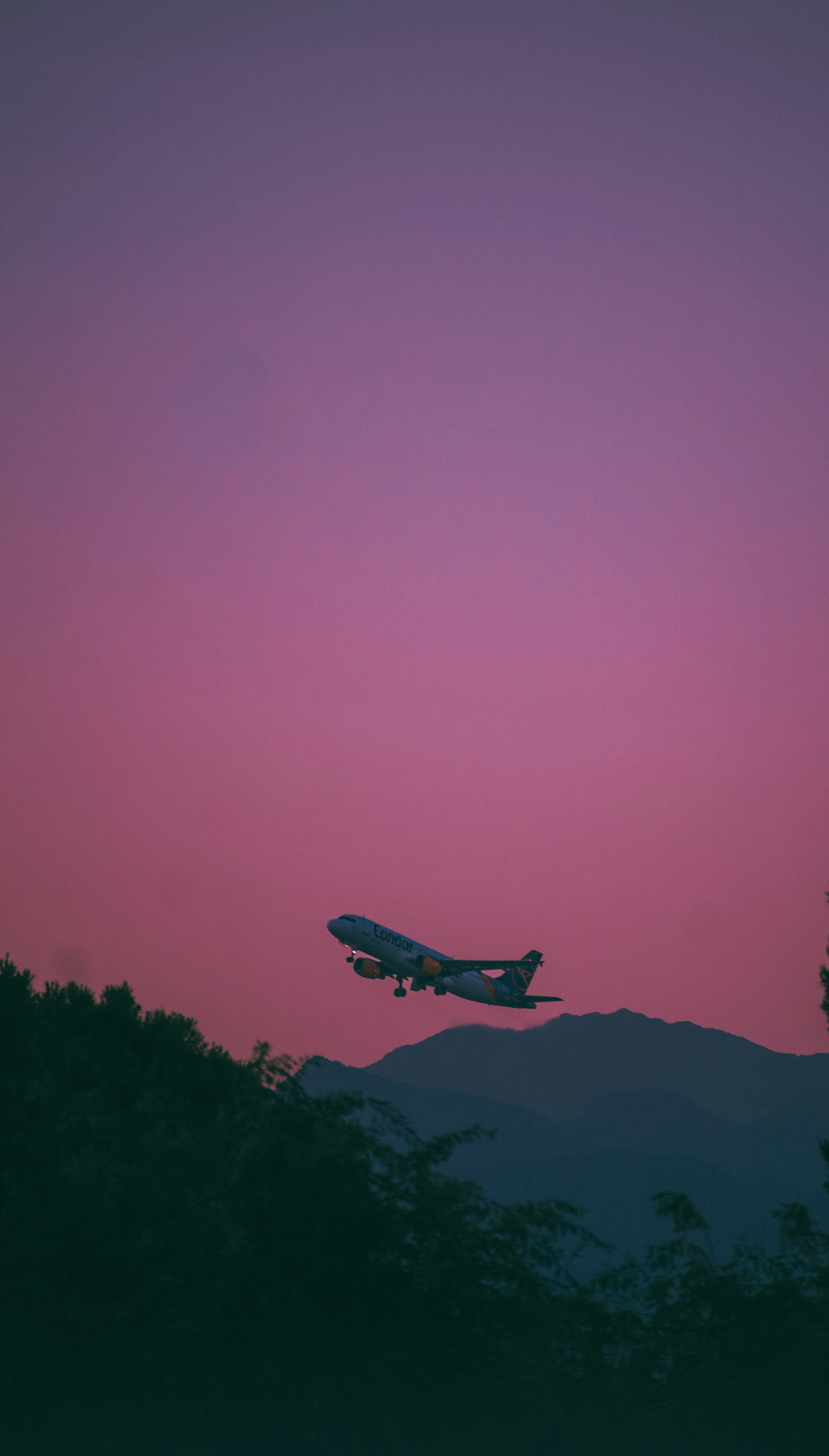 Lavender Twilight Lift-Off: Jet Ascends Over Dusky Hills