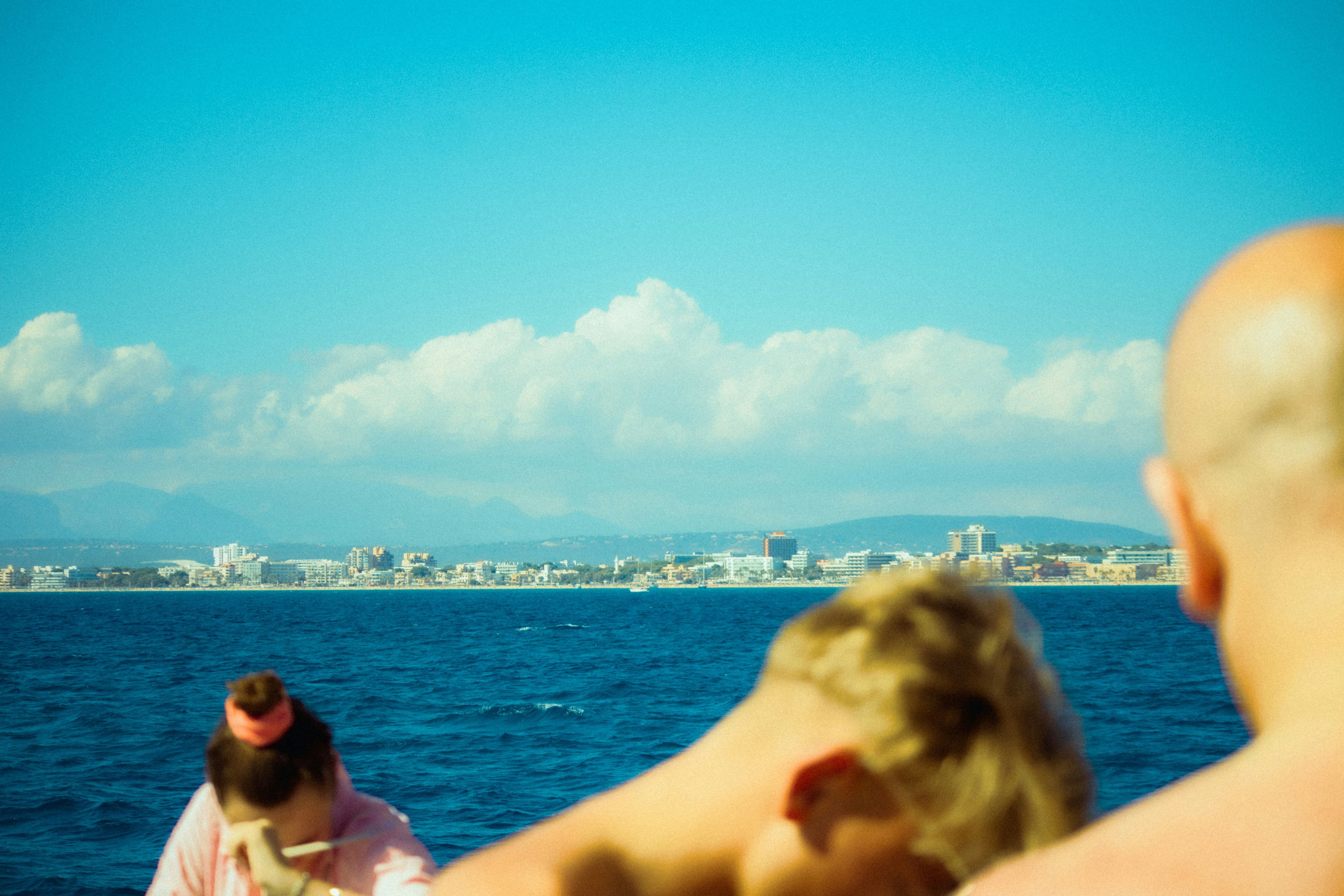 Blurry Beach Heads: A Pair of Sun-Drenched Figures by the Sea