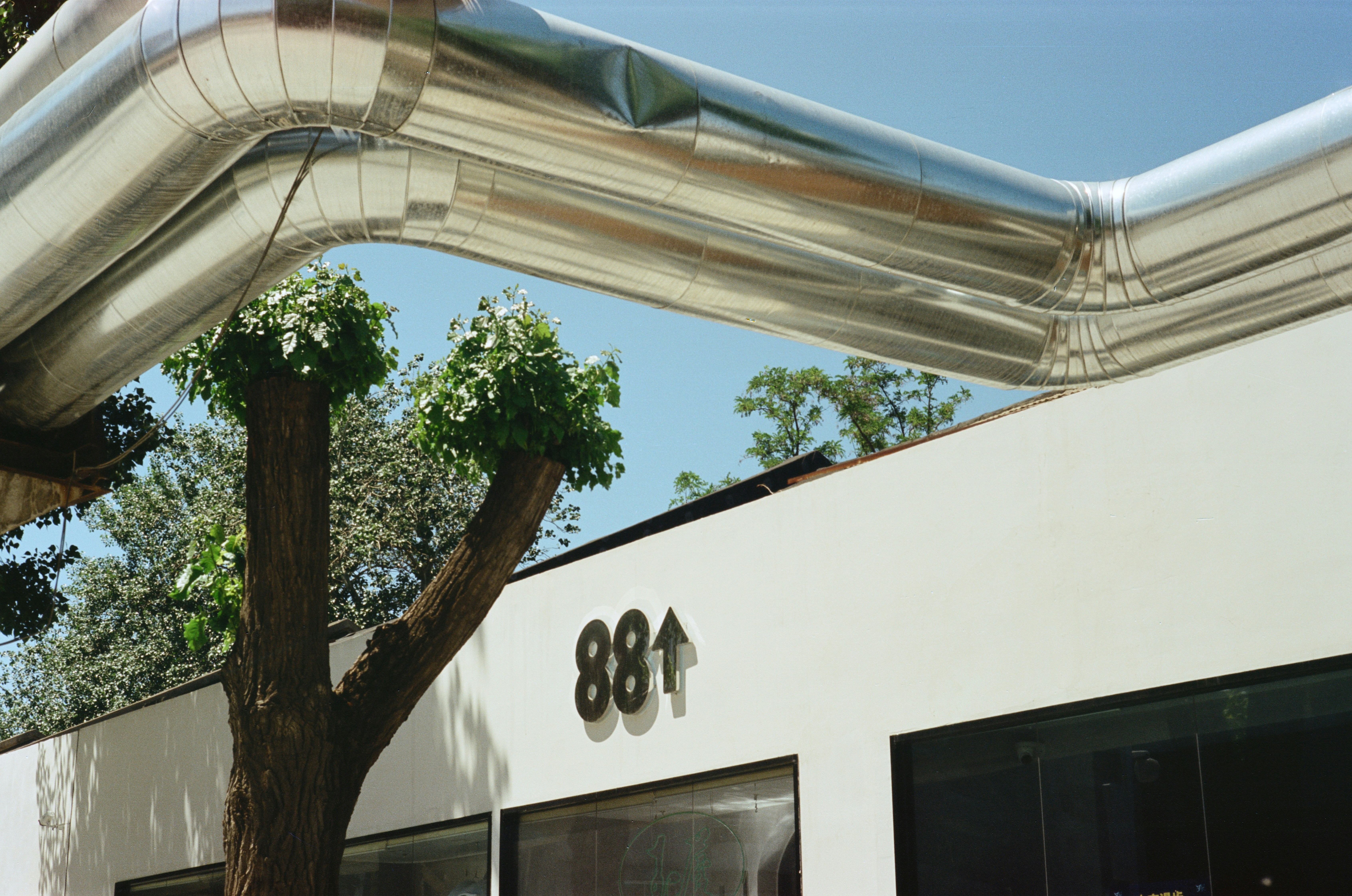 A building with a large metal pipe on top of it photo – Free Analogue ...