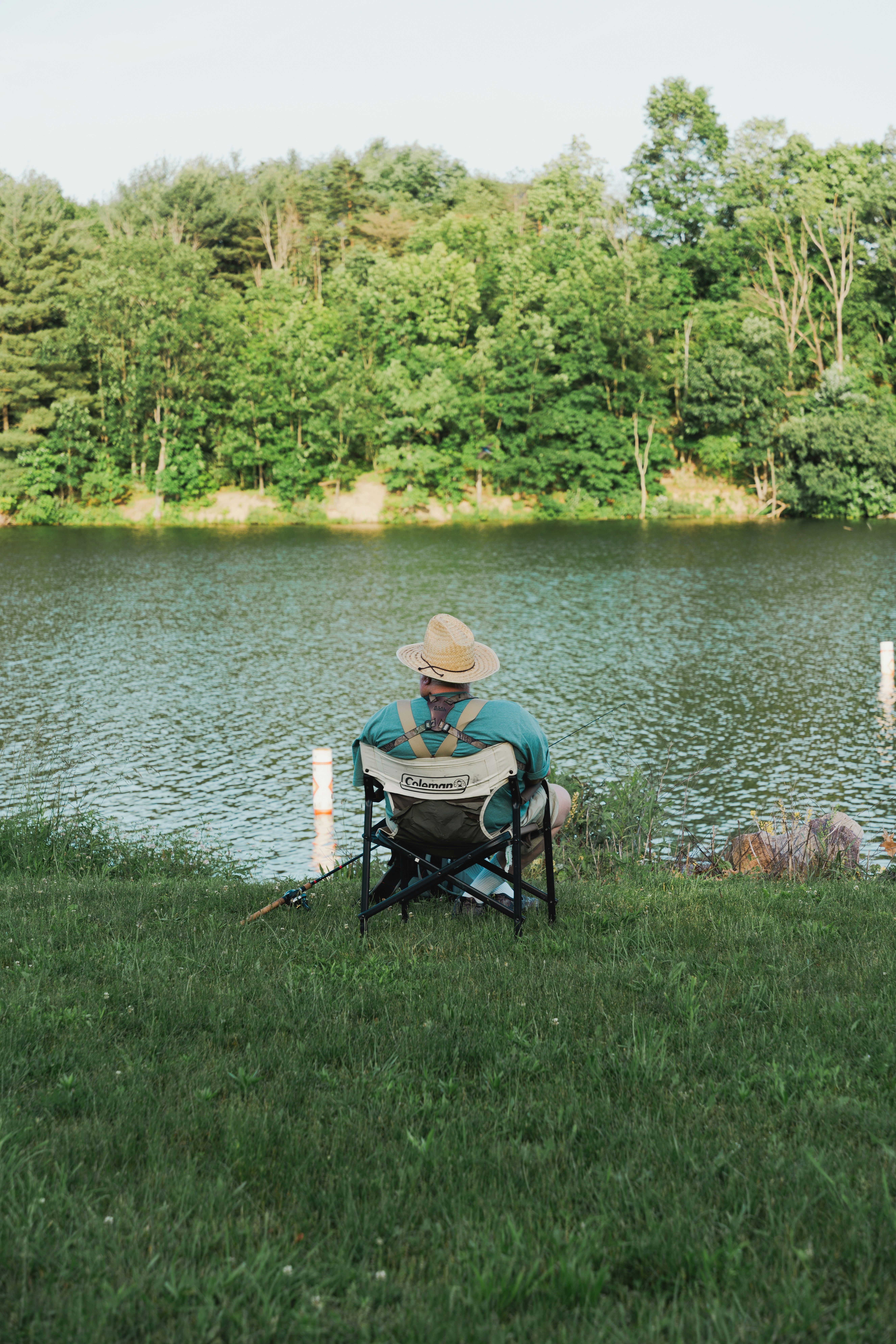 a person sitting in a chair near a body of water