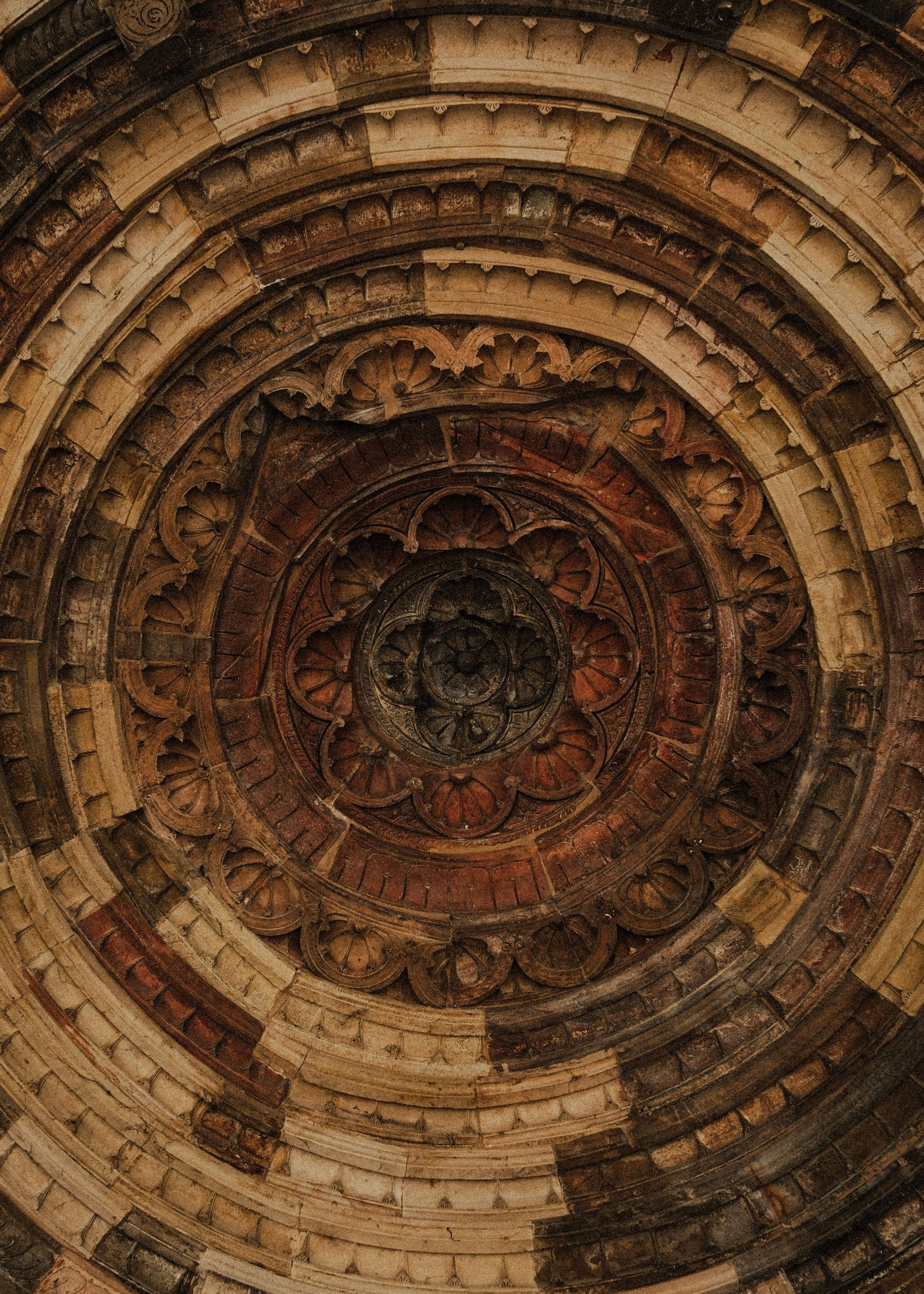 Concentric Stone Rosettes: A Circular Carved Ceiling Portrait