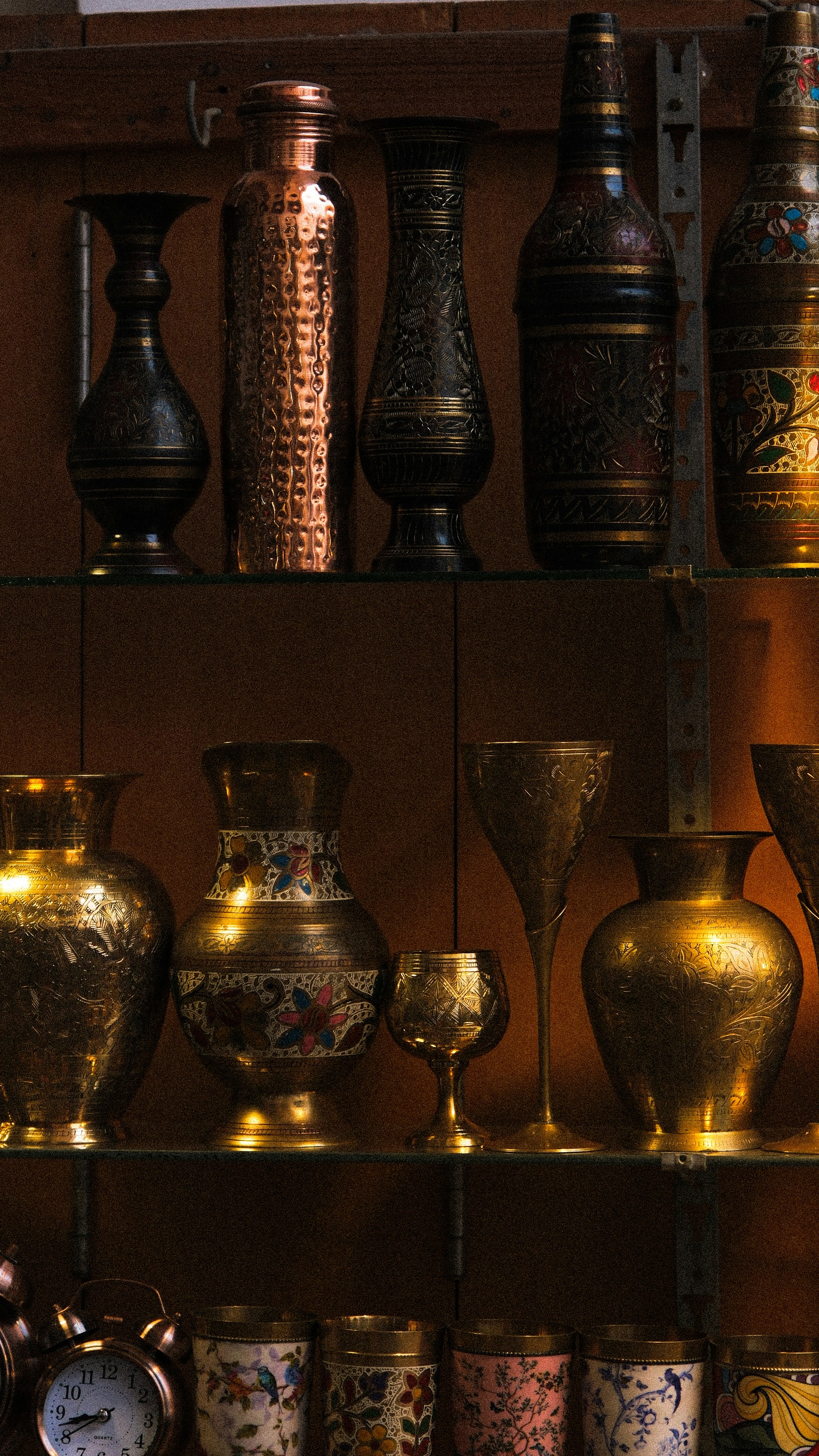 Copper and ceramic vessels on a shelved display