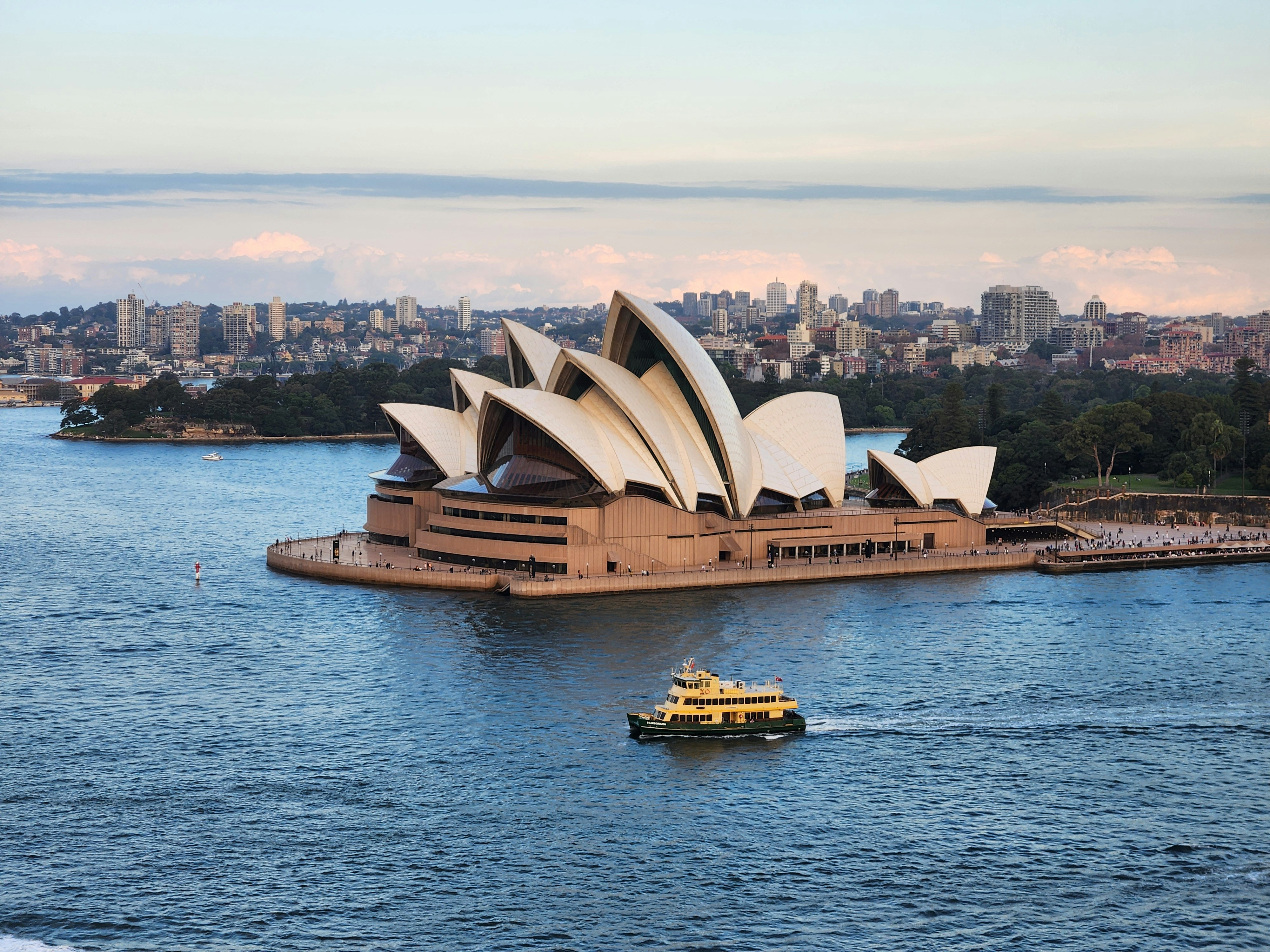 a boat is in the water near a large building