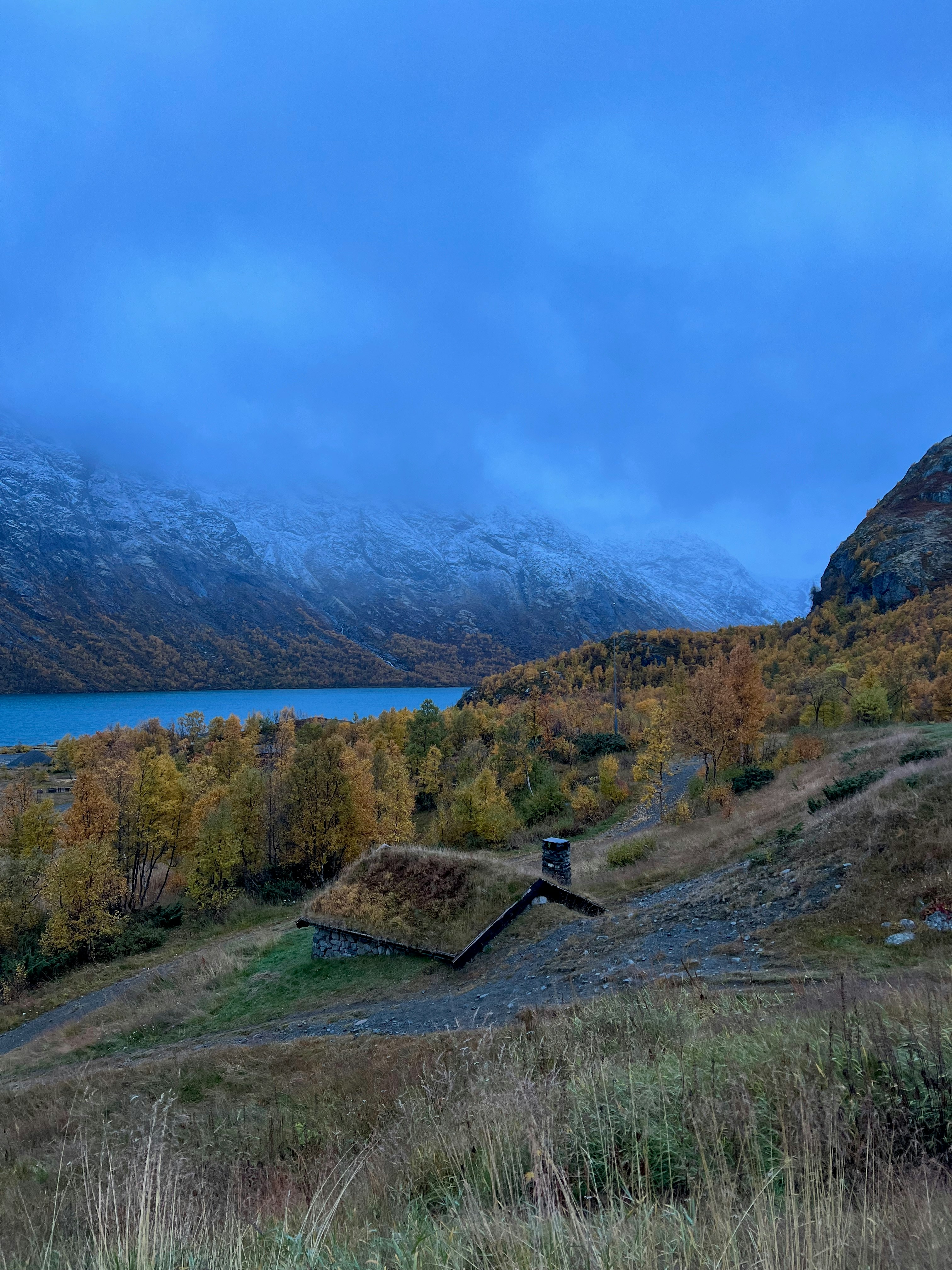 Autumn Cabin Beneath Frosted Peaks by a Quiet Alpine Lake