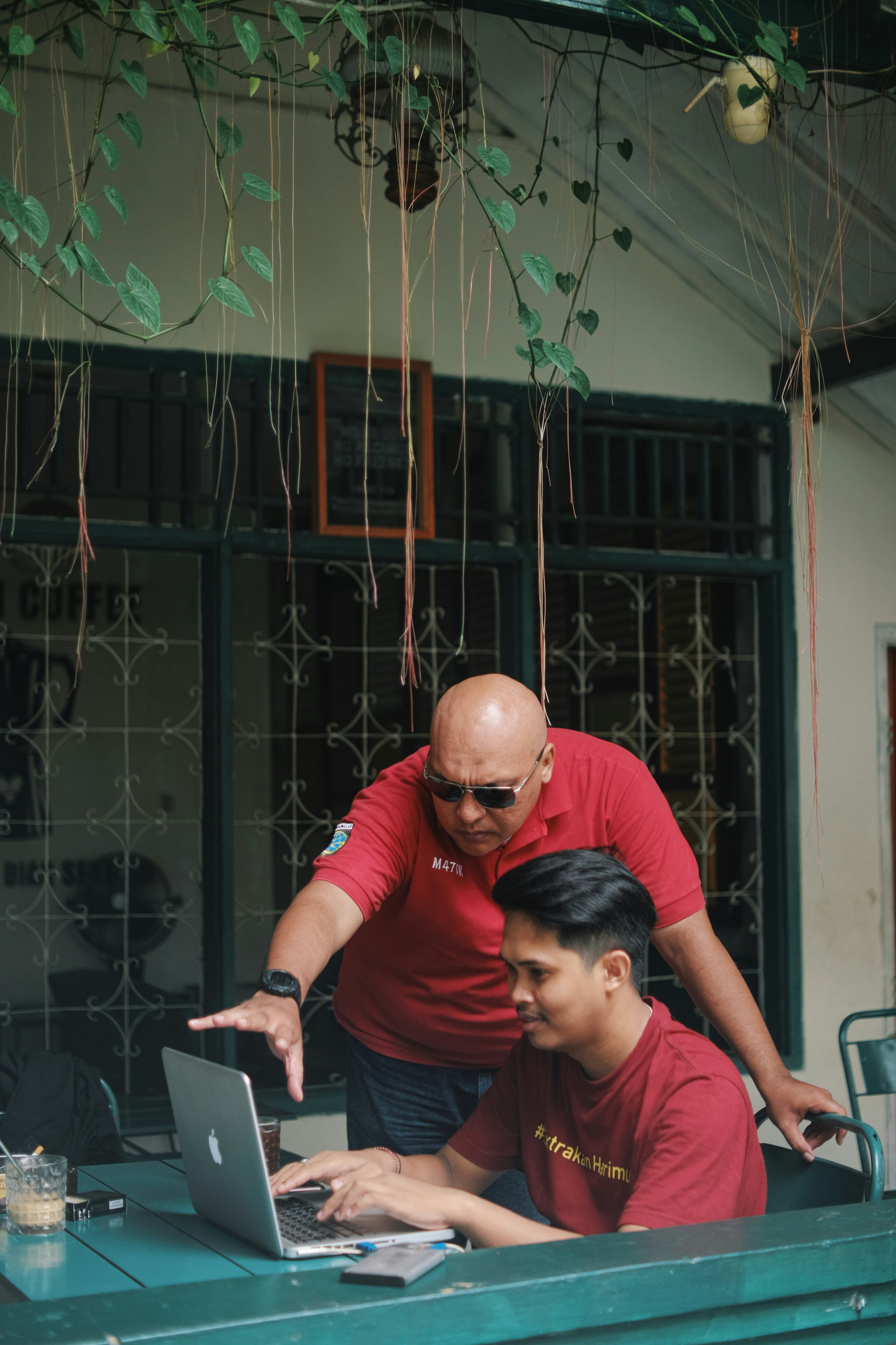Guided Collaboration: Two Developers Shaping Code at a Cozy Outdoor Desk