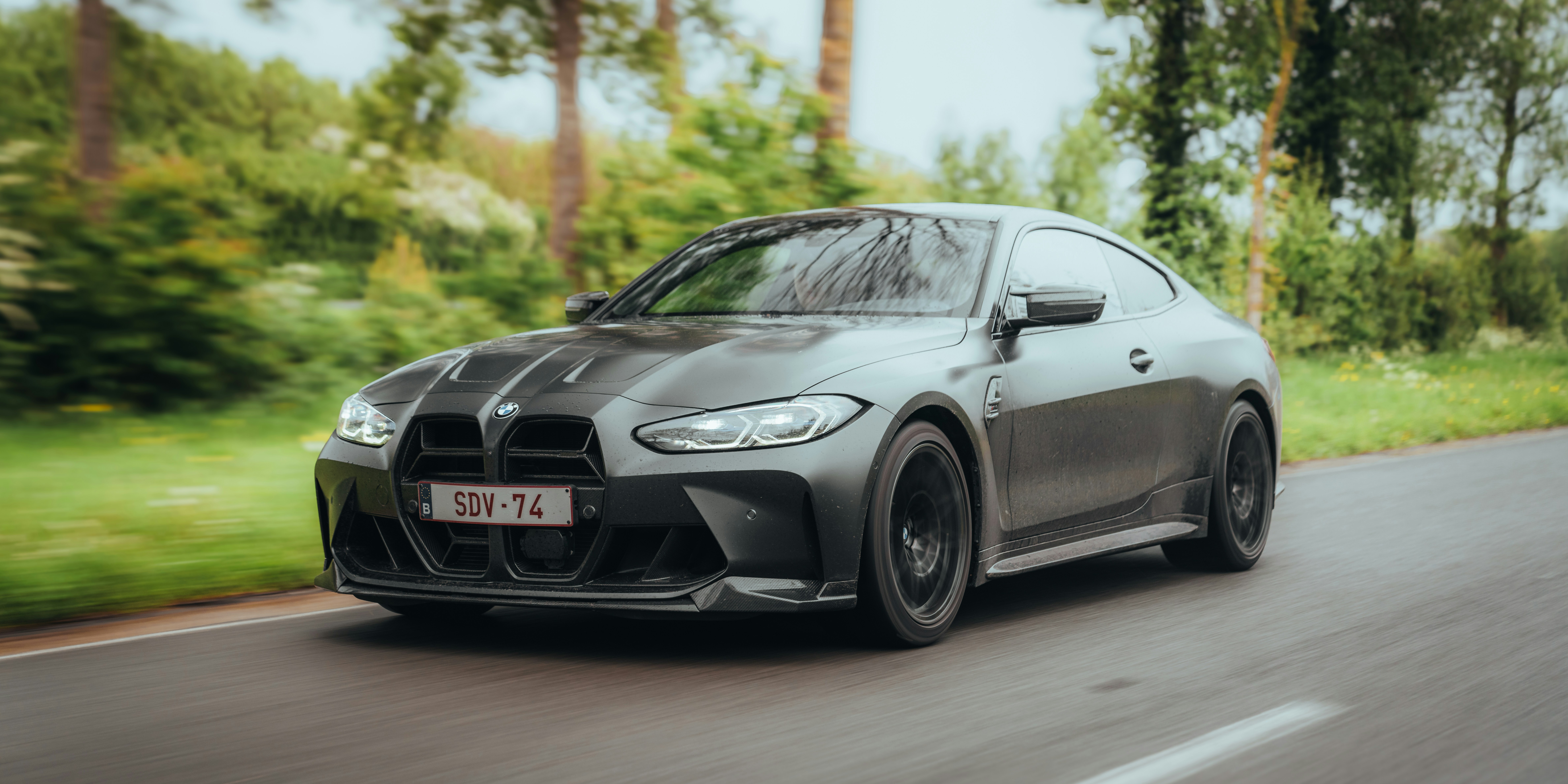 A grey sports car driving down the road photo – Free Car Image on Unsplash