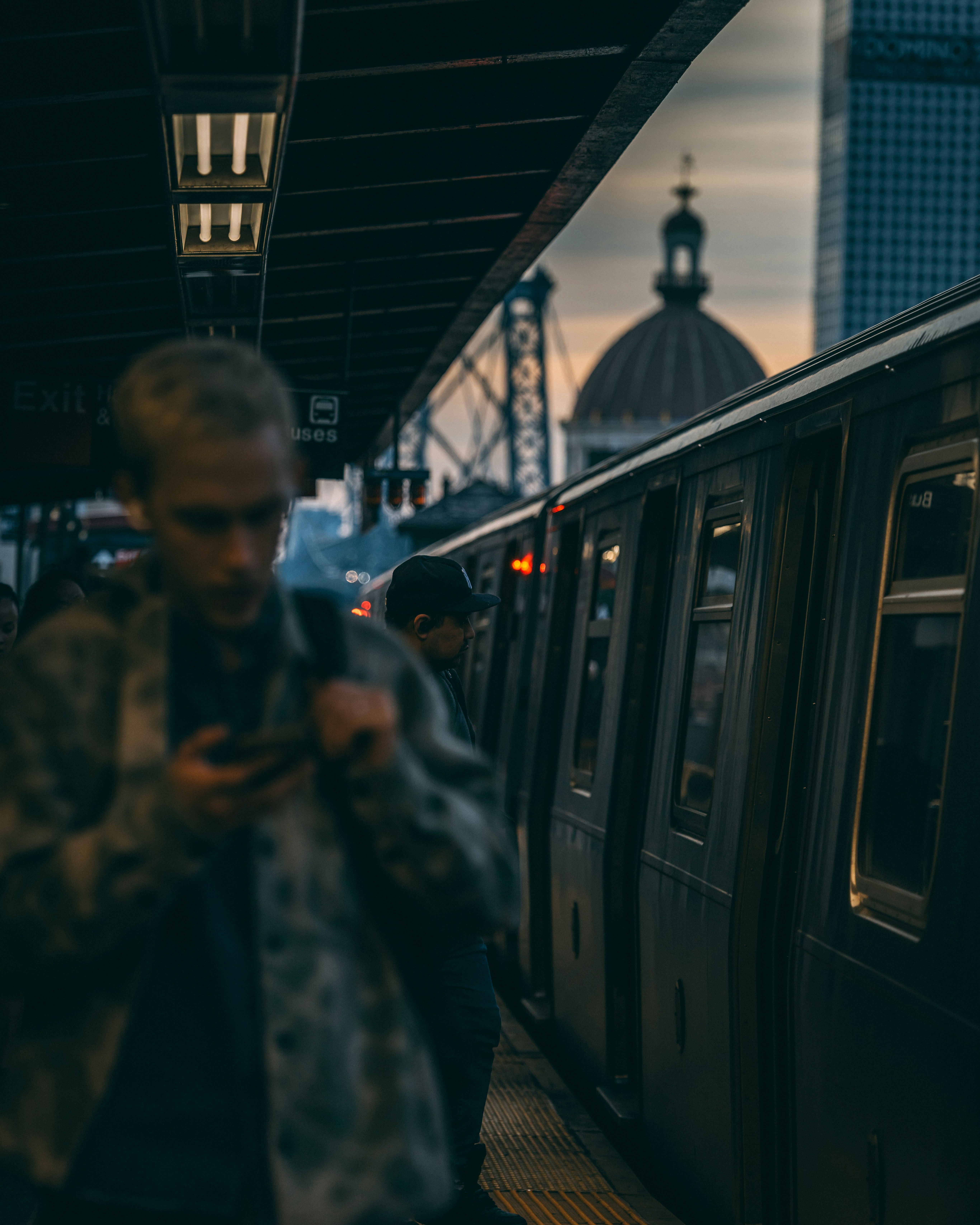 A man standing next to a train at a train station photo – Free Marcy ...