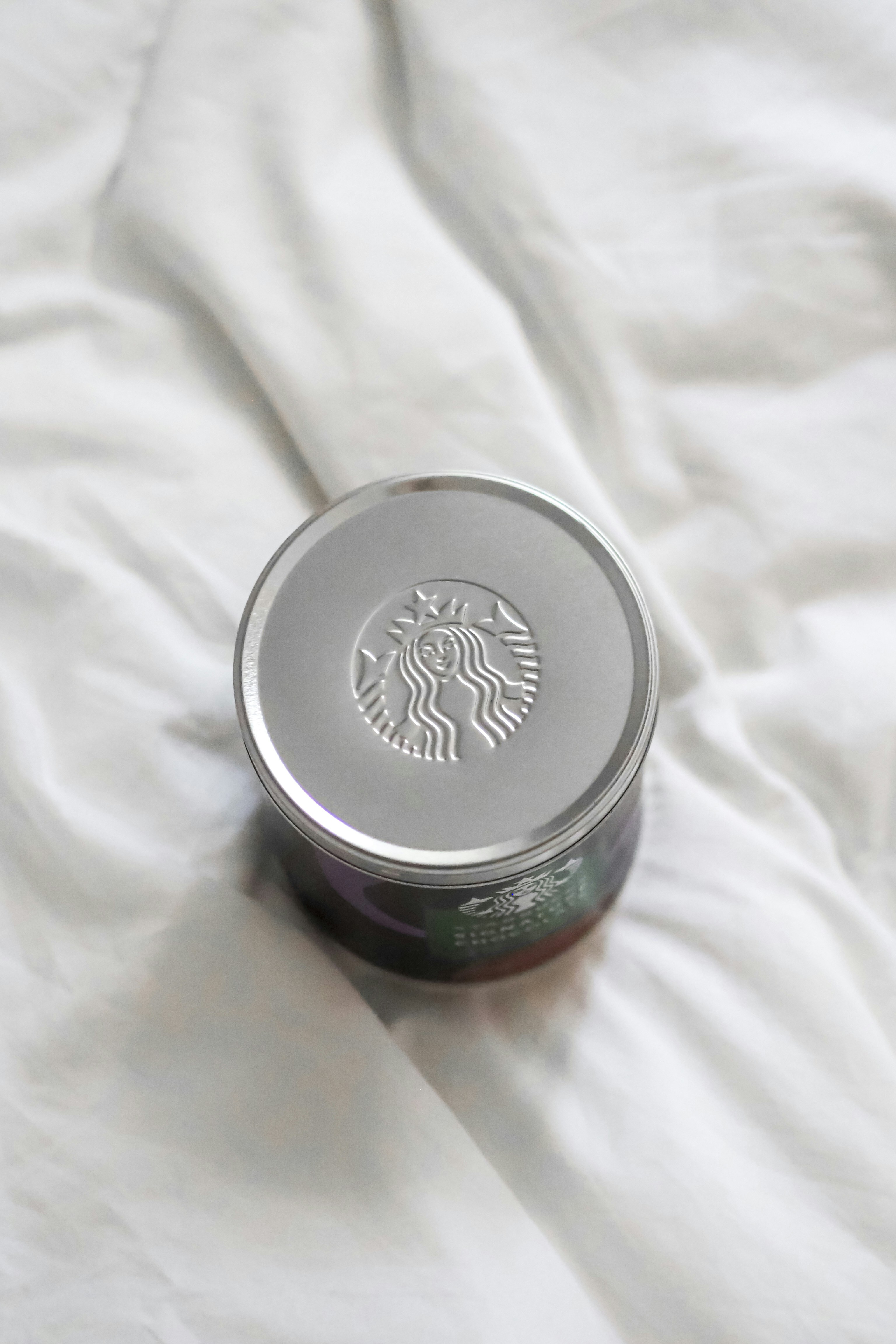 A can of starbucks coffee sitting on a bed photo – Free Jar Image on ...