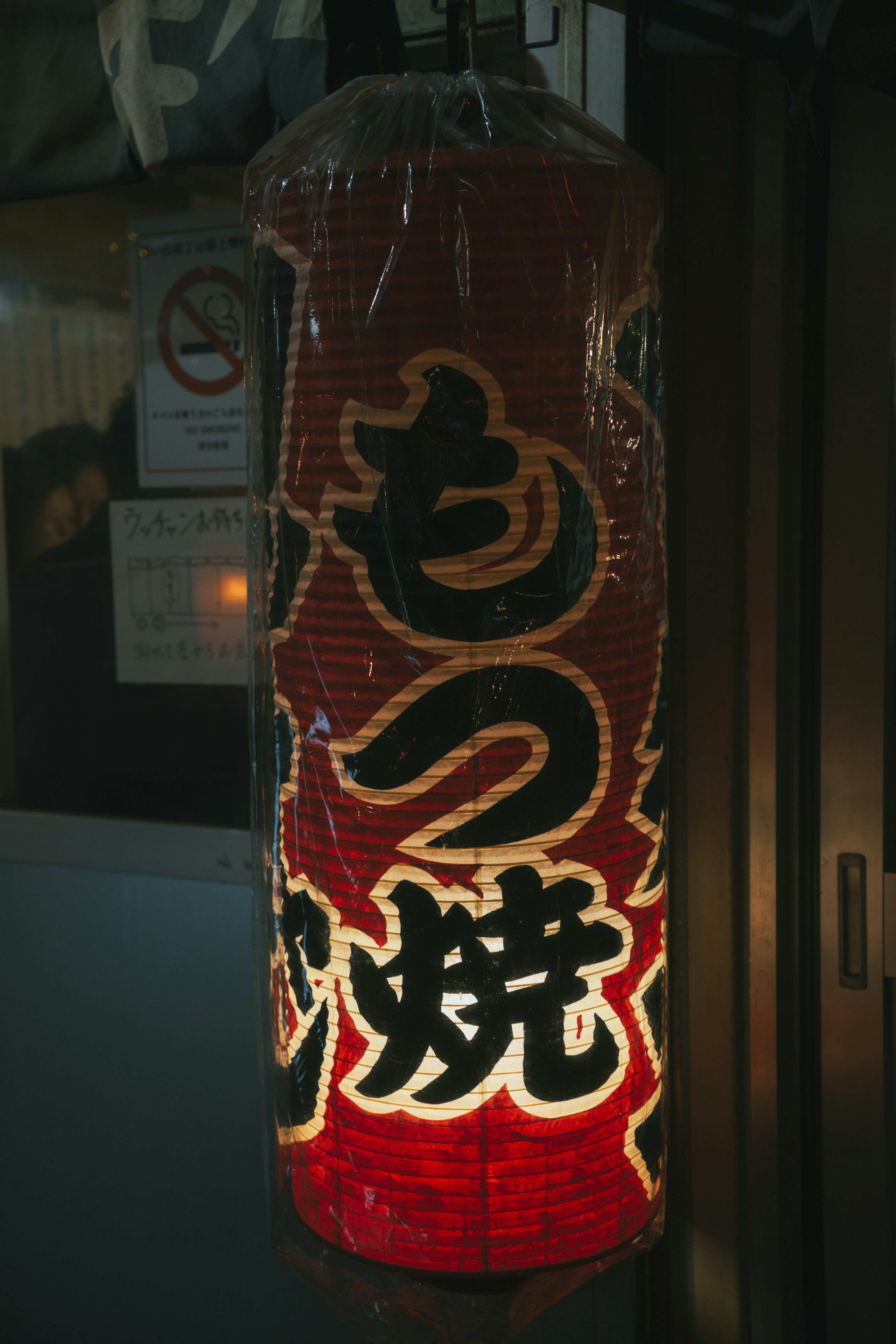 Red Lantern Looms in Dim Street Glow