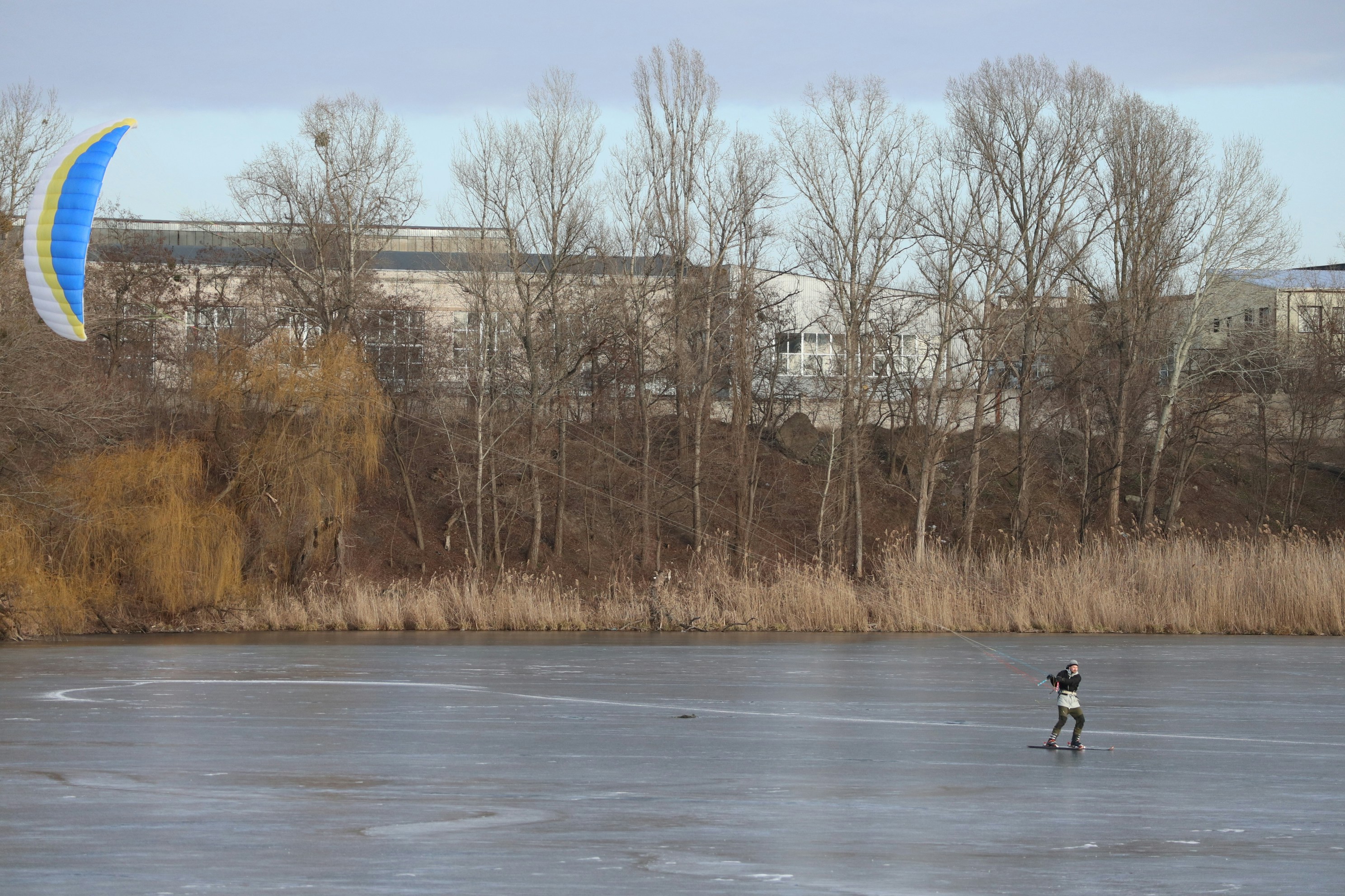 Skater against a winter-lake horizon