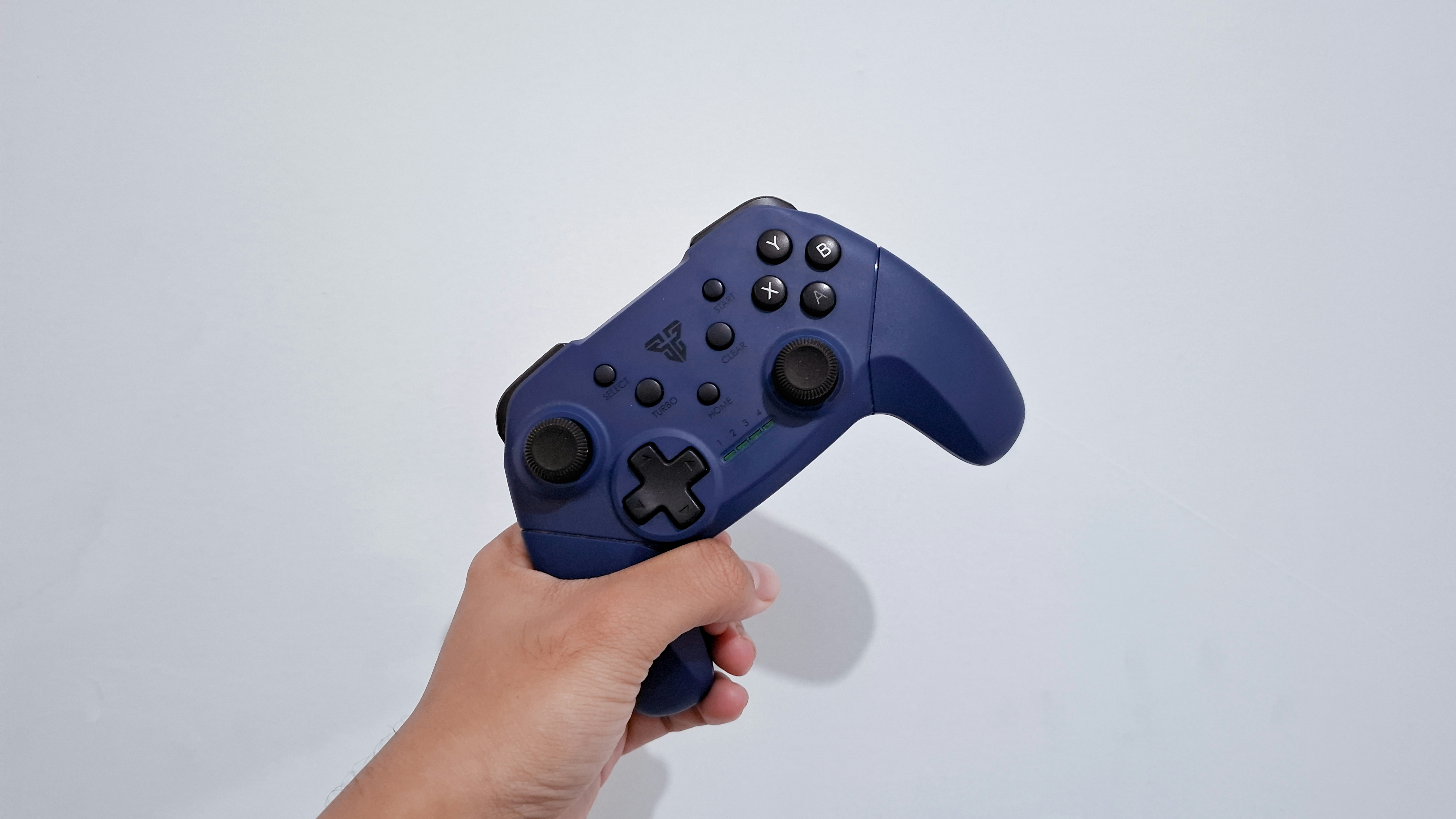 A hand holding a blue nintendo wii controller photo – Free Bekasi Image ...