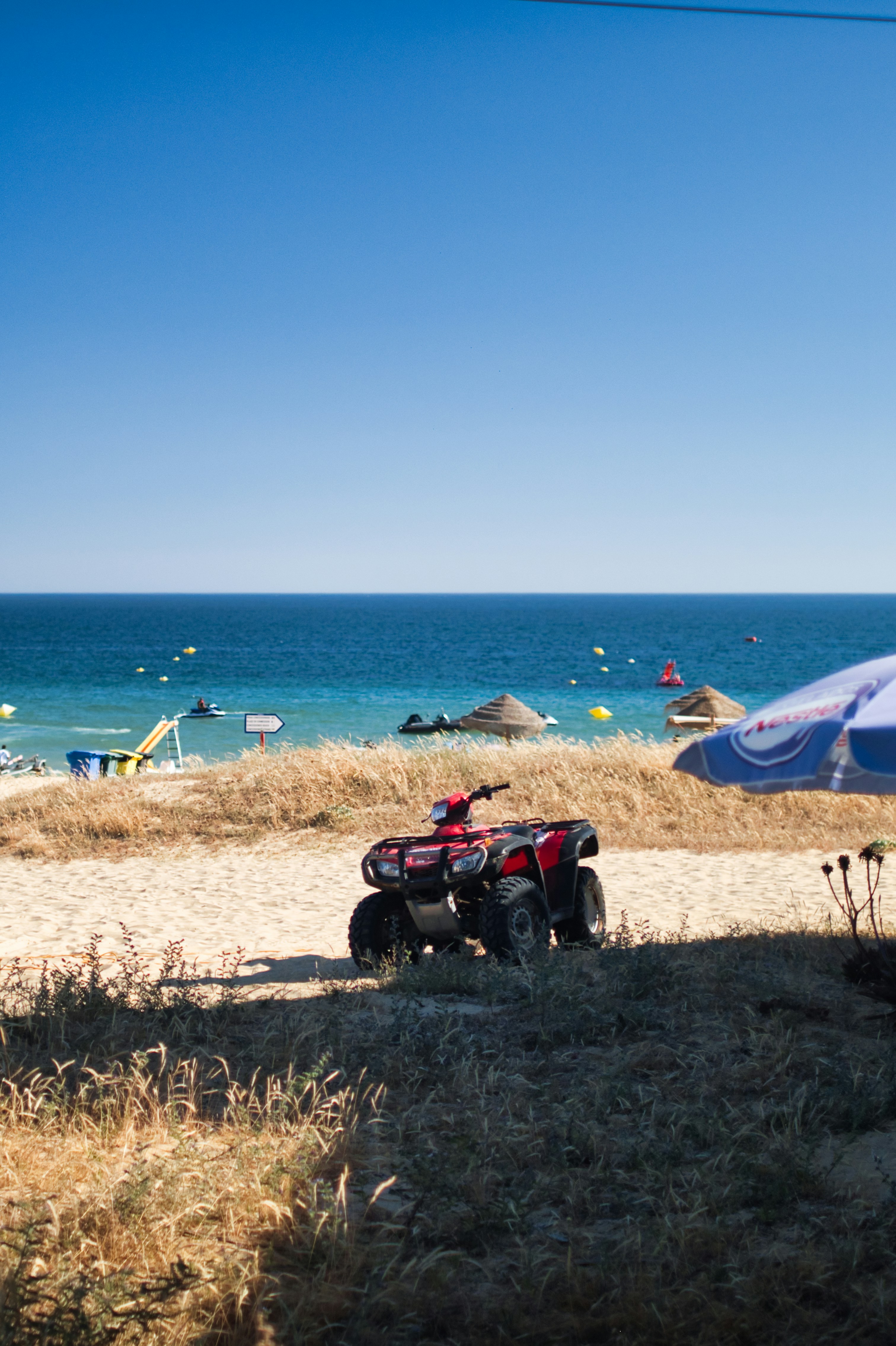 A person riding a four wheeler on a beach photo – Free Beach Image on ...