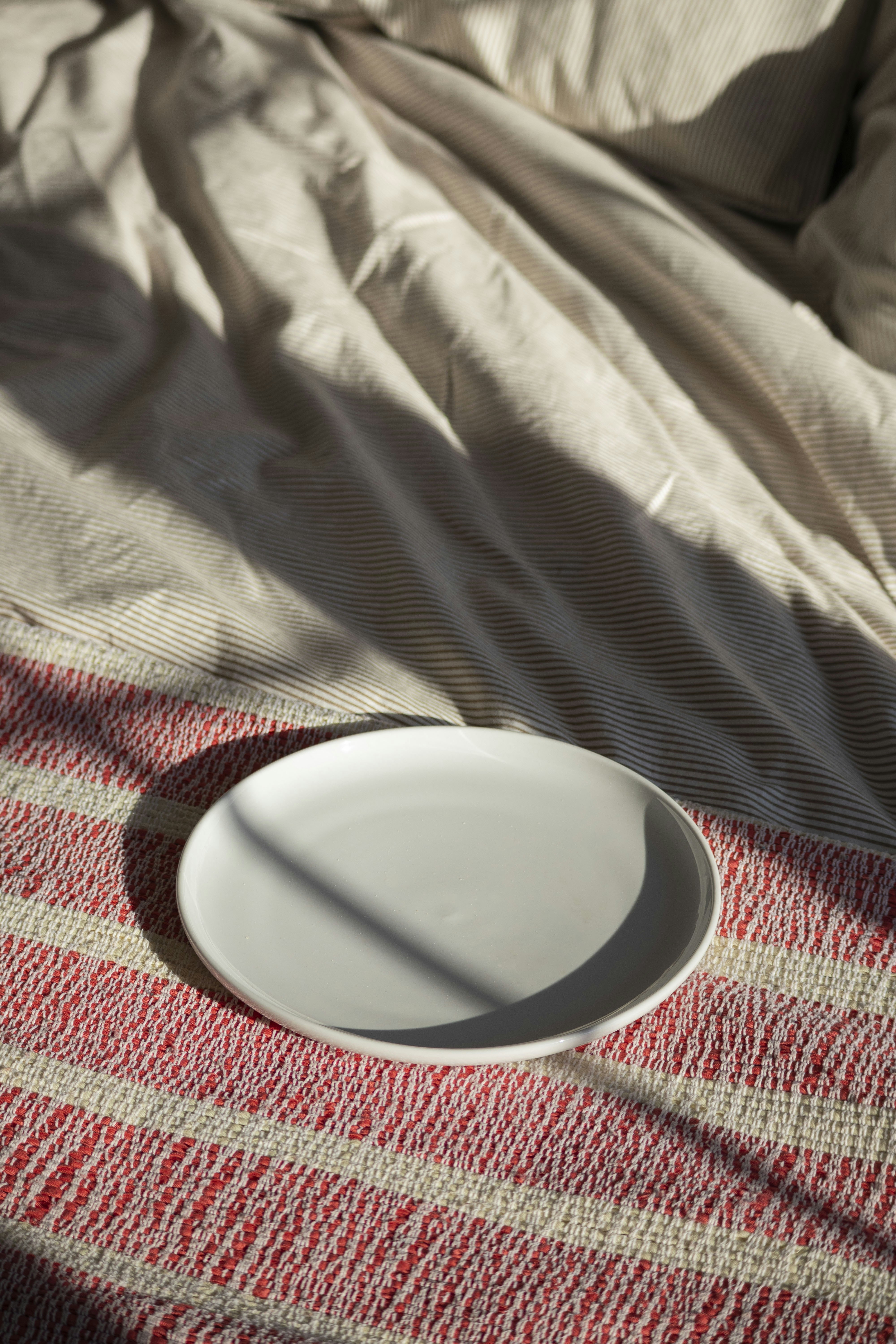 Sunlit Plate on Red Linen: Quiet Geometry of a Simple Moment