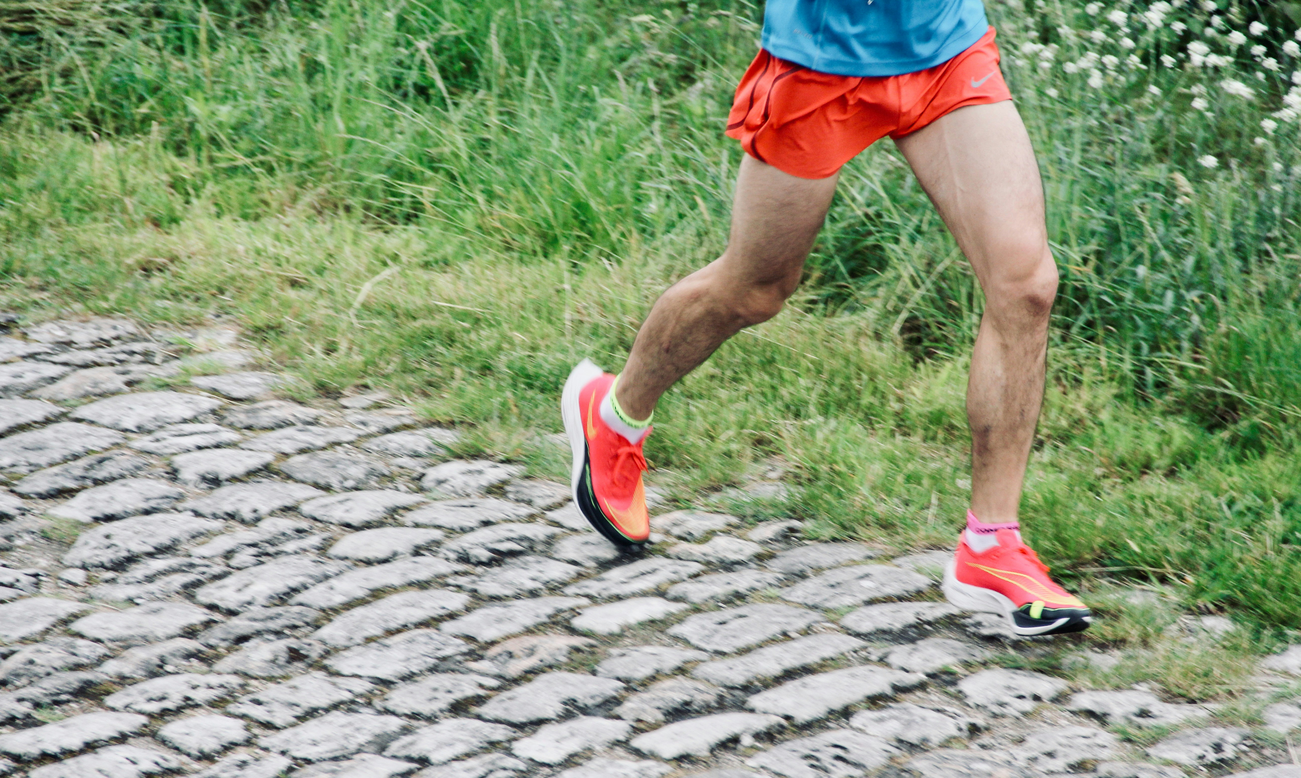 A man running down a cobblestone road photo – Free Human Image on Unsplash