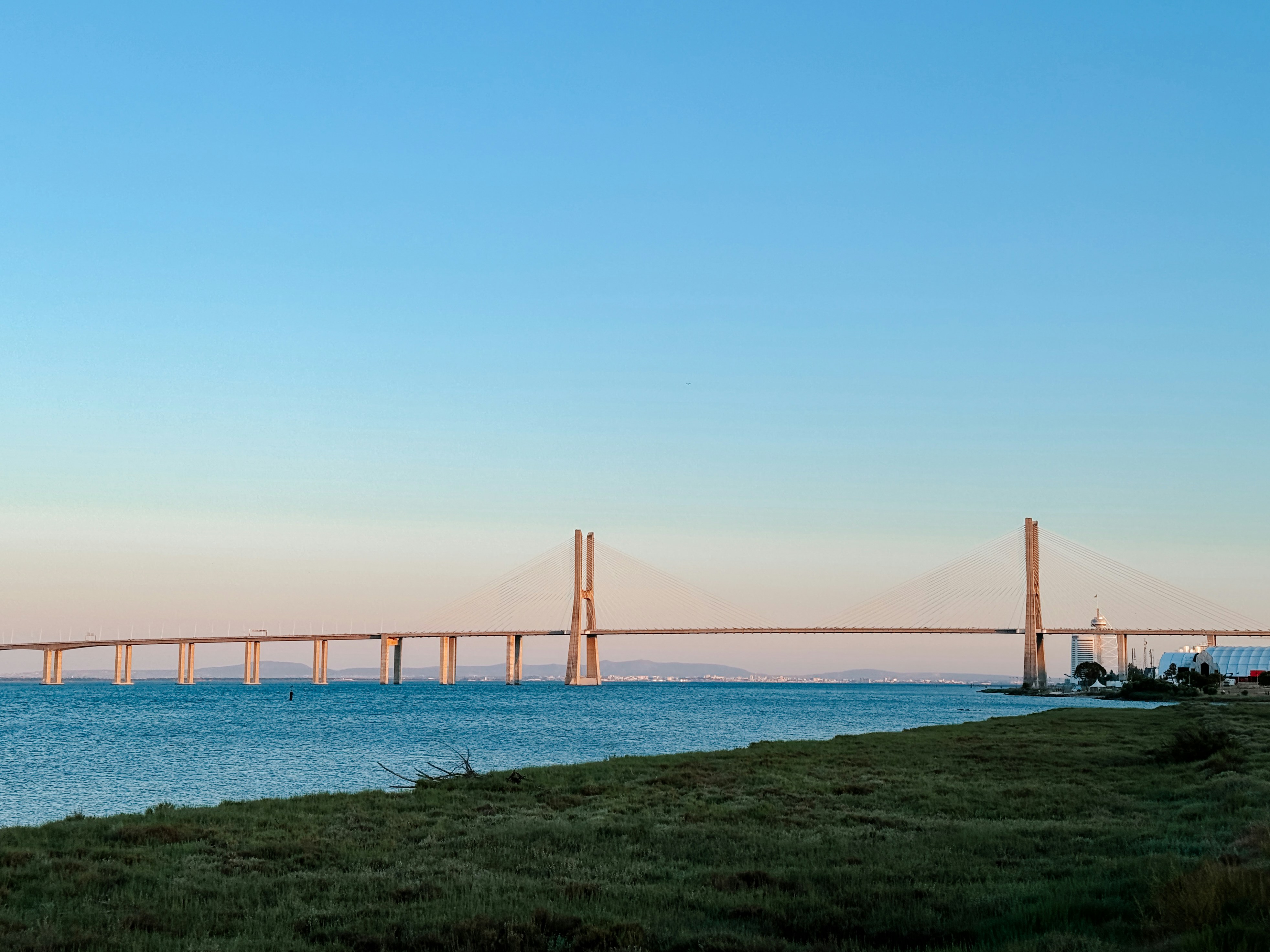 A large bridge over a large body of water photo – Free Parque do tejo ...